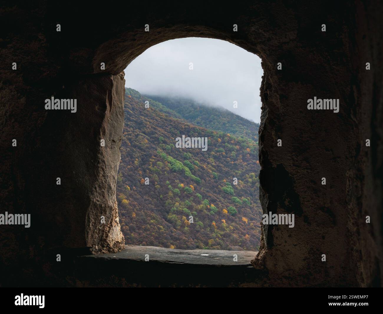 Old stone window. View through arched window in old stone abandoned ...