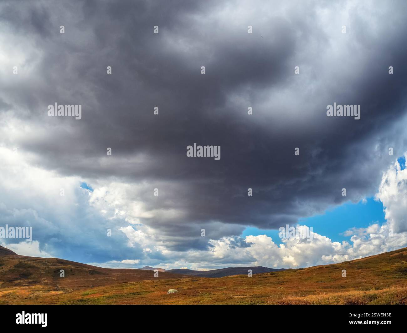 Terrible thunderclouds have hung over the autumn valley. The sky before ...