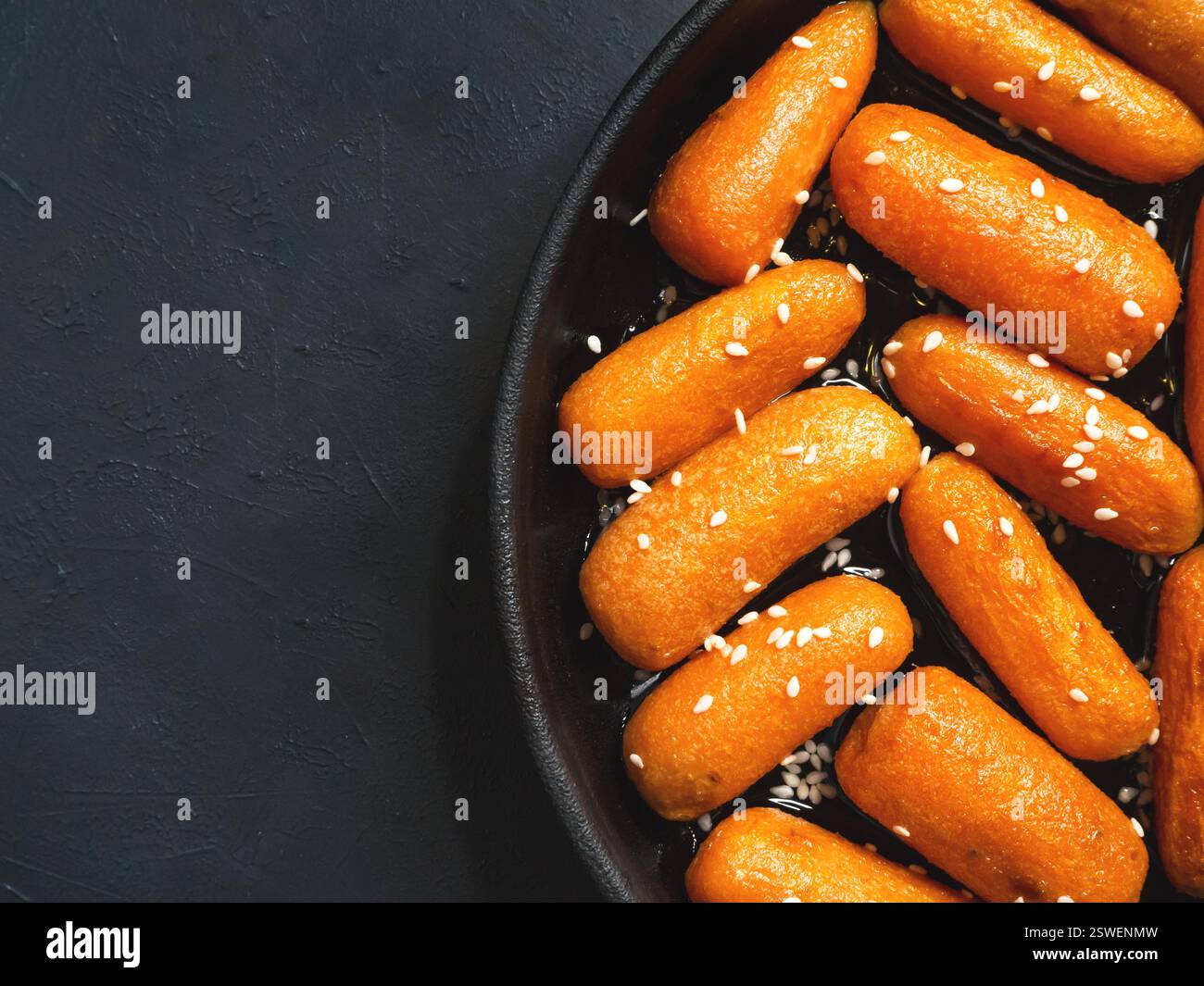 Roasted Baby Carrots with Honey and Ginger. Small carrots on a serving ...
