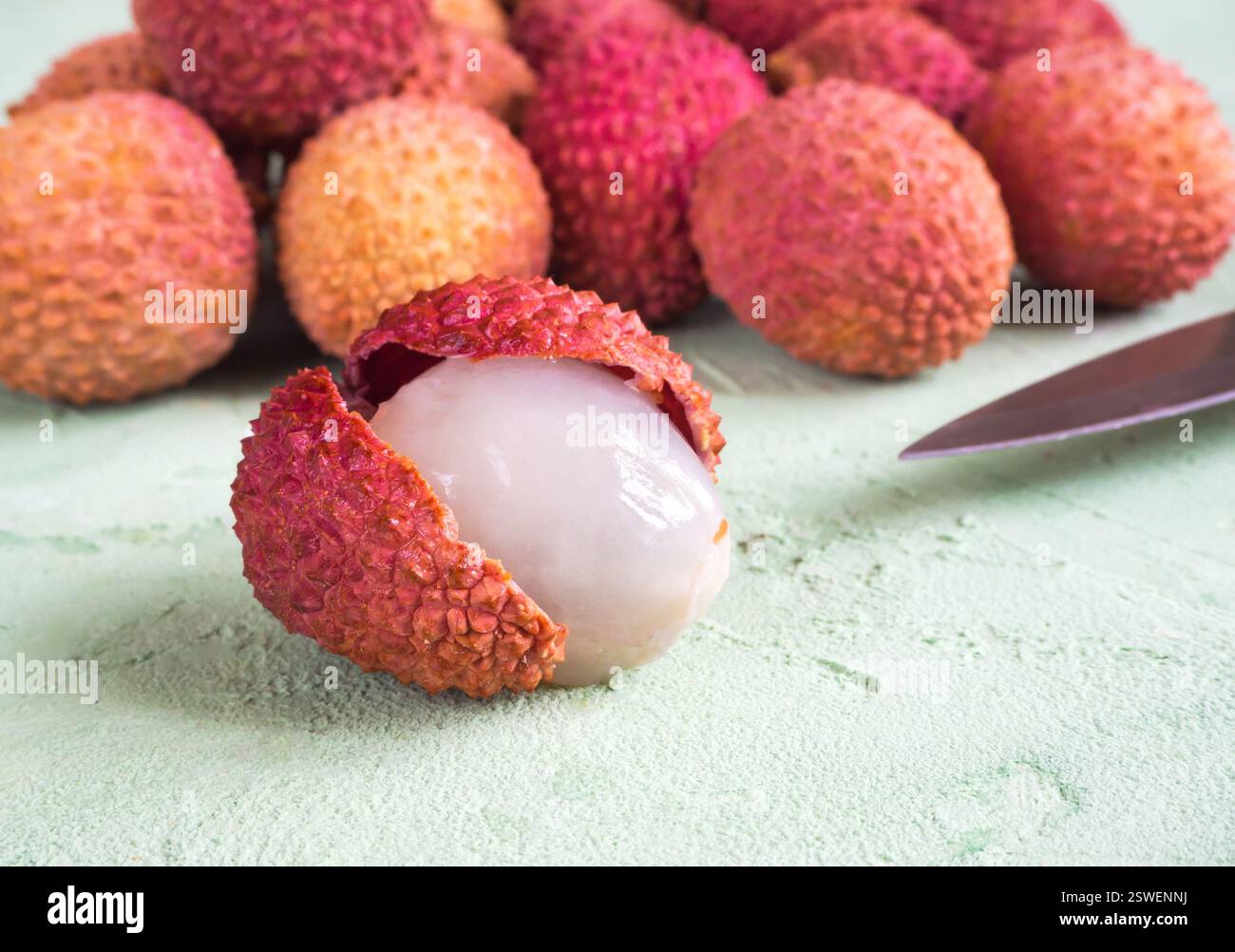Ripe lychees on a green table peeled lychee fruit hi-res stock ...