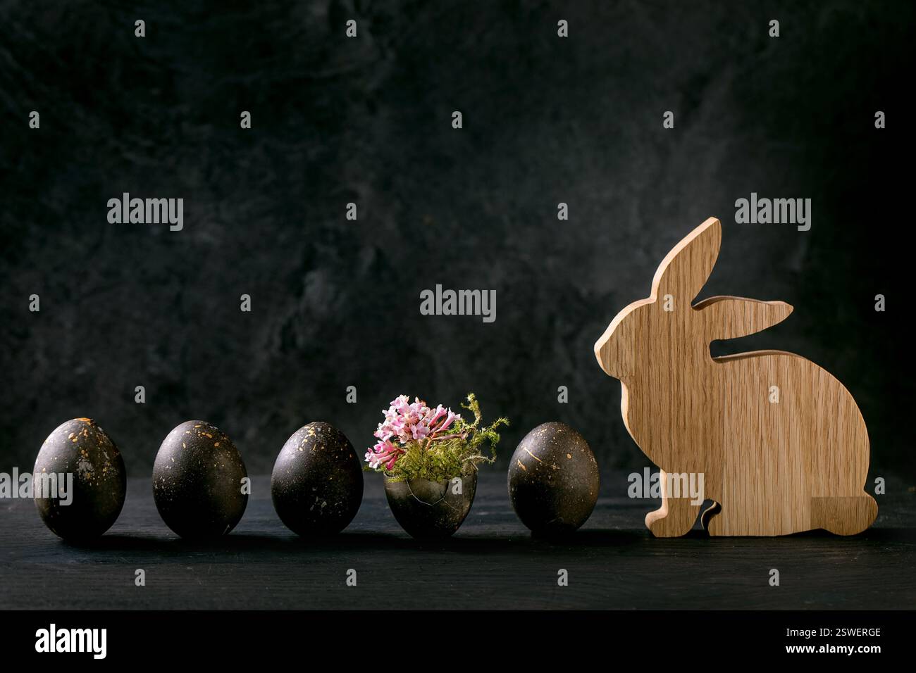 Black Easter concept. Bio colored black eggs with golden spots with ...