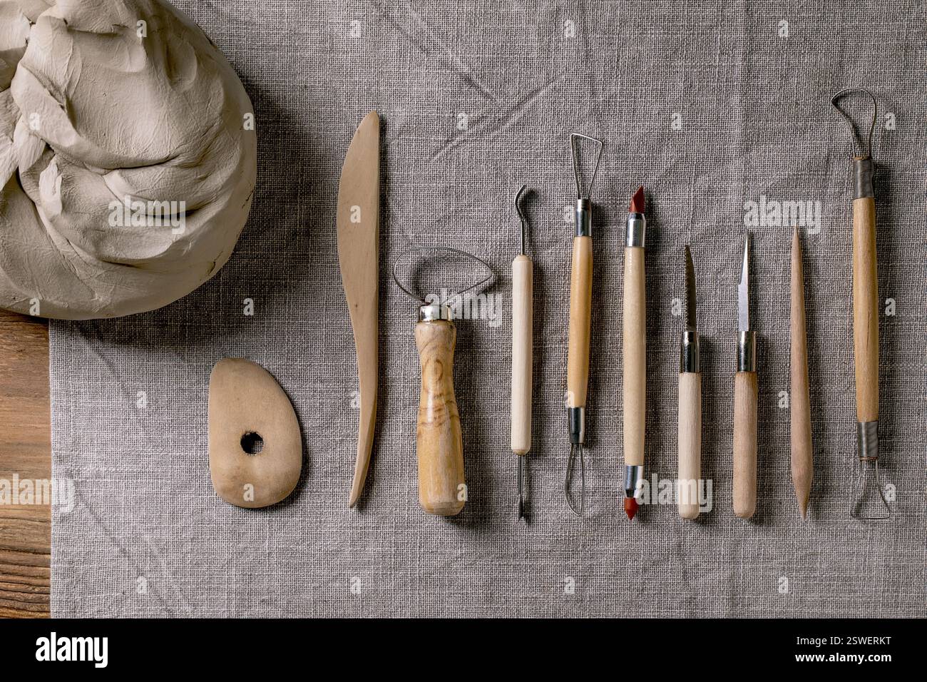 Set for pottery hobby. Piece of raw grey clay and kit of pottery ...