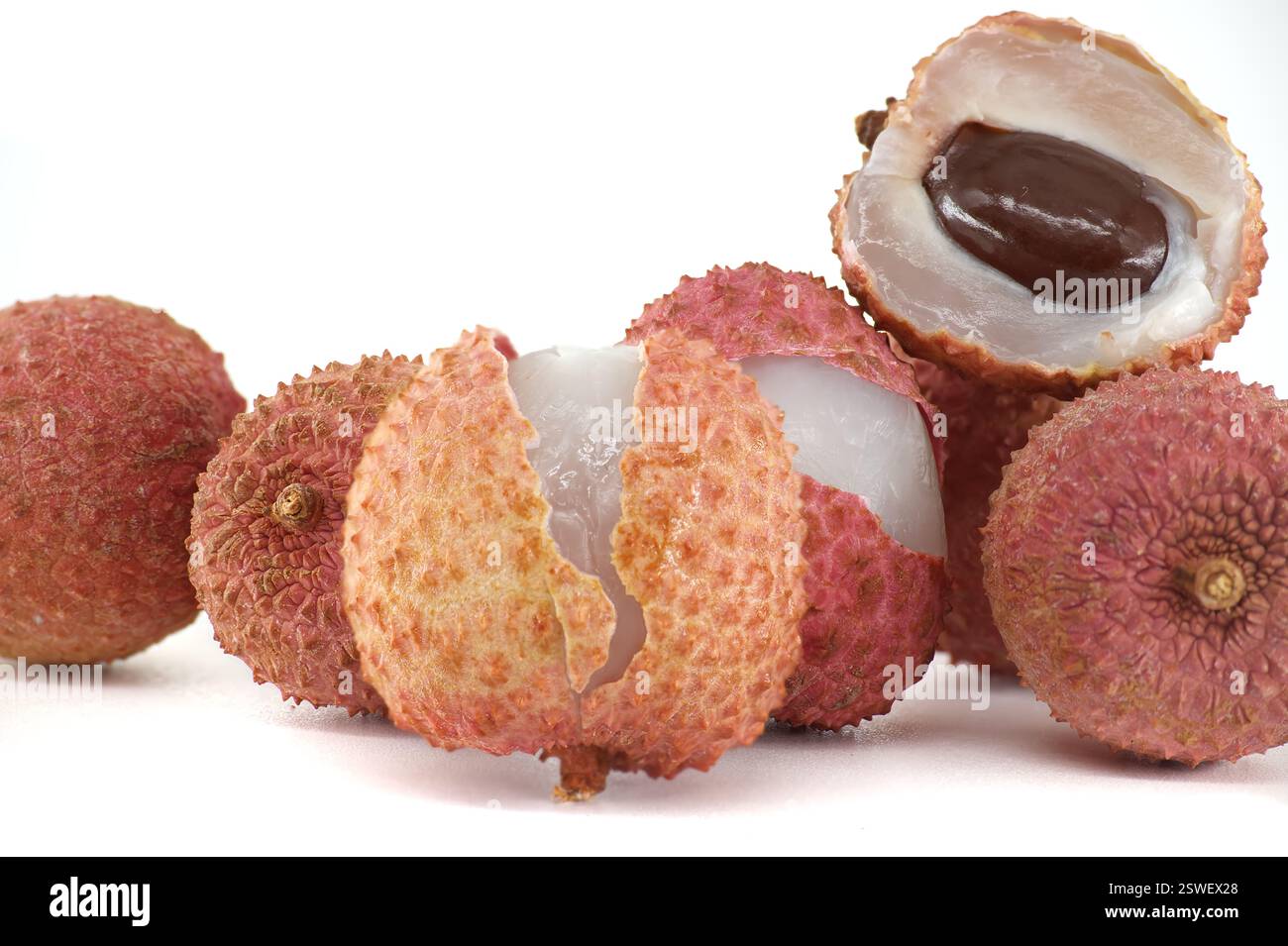 Ripe lychee fruits shown whole and peeled, displaying their juicy ...
