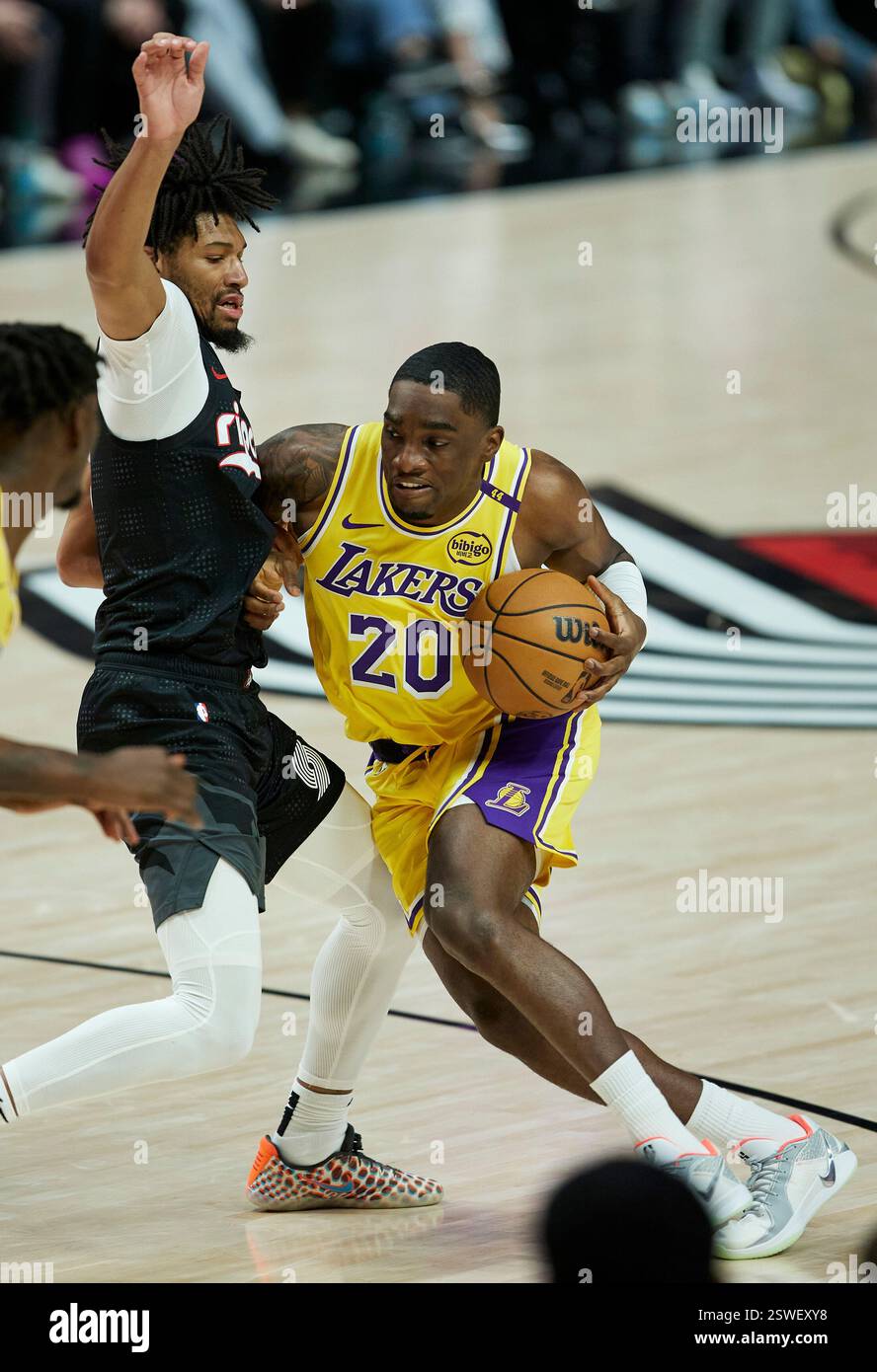 Los Angeles Lakers guard Shake Milton, right, dribbles around Portland ...