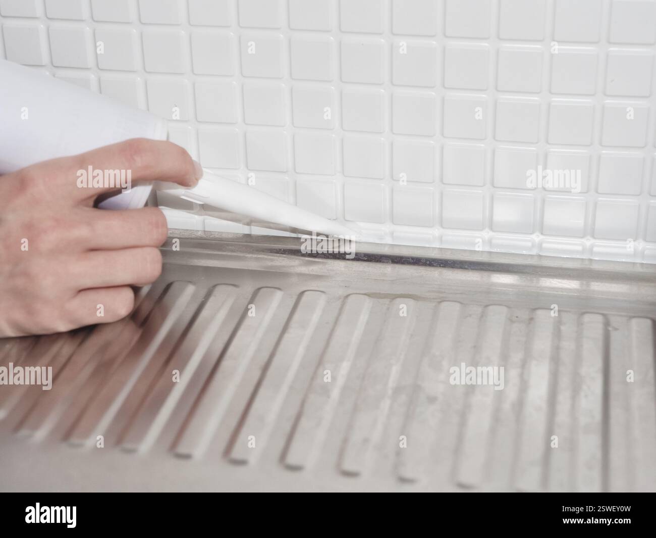 Using silicone adhesive to installing a sink in the kitchen ...