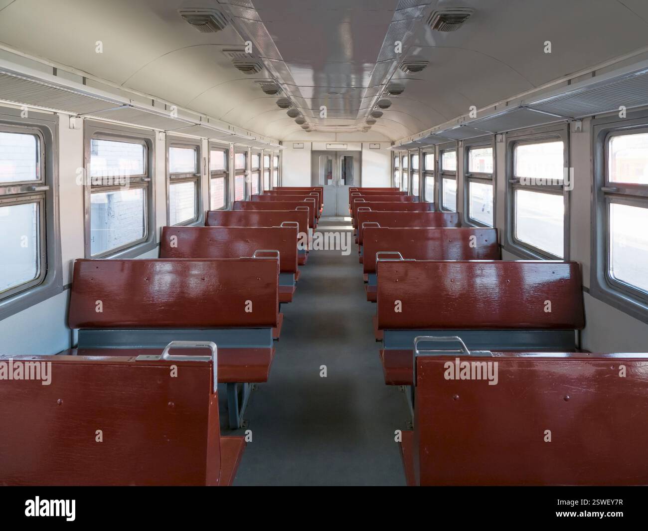Empty train car with seats perspective Stock Photo - Alamy