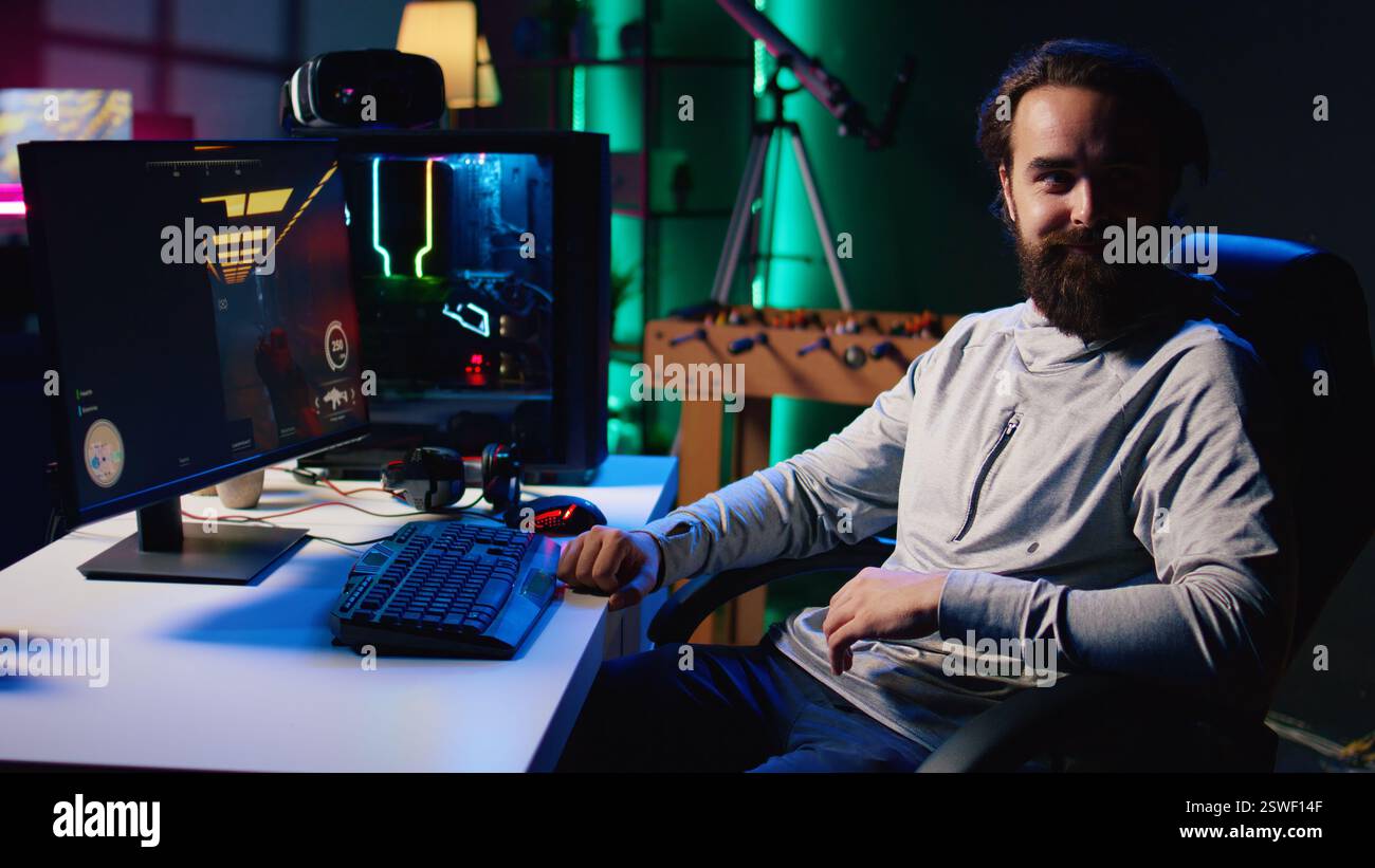 Portrait of cheerful man playing first person shooter videogame with ...
