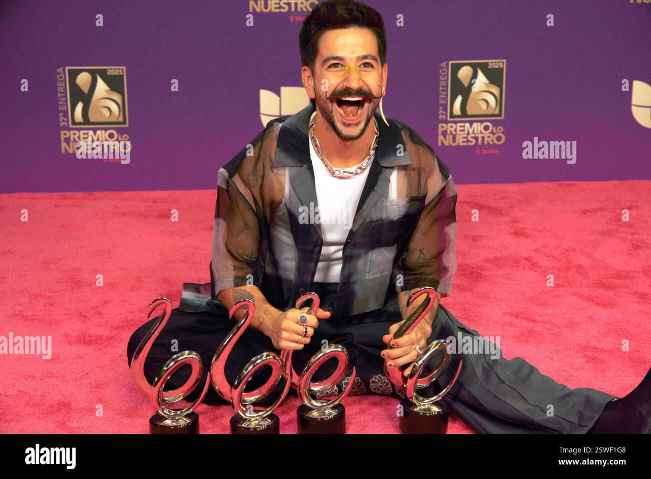 Miami, United States. 20th Feb, 2025. Camilo displays his four awards ...