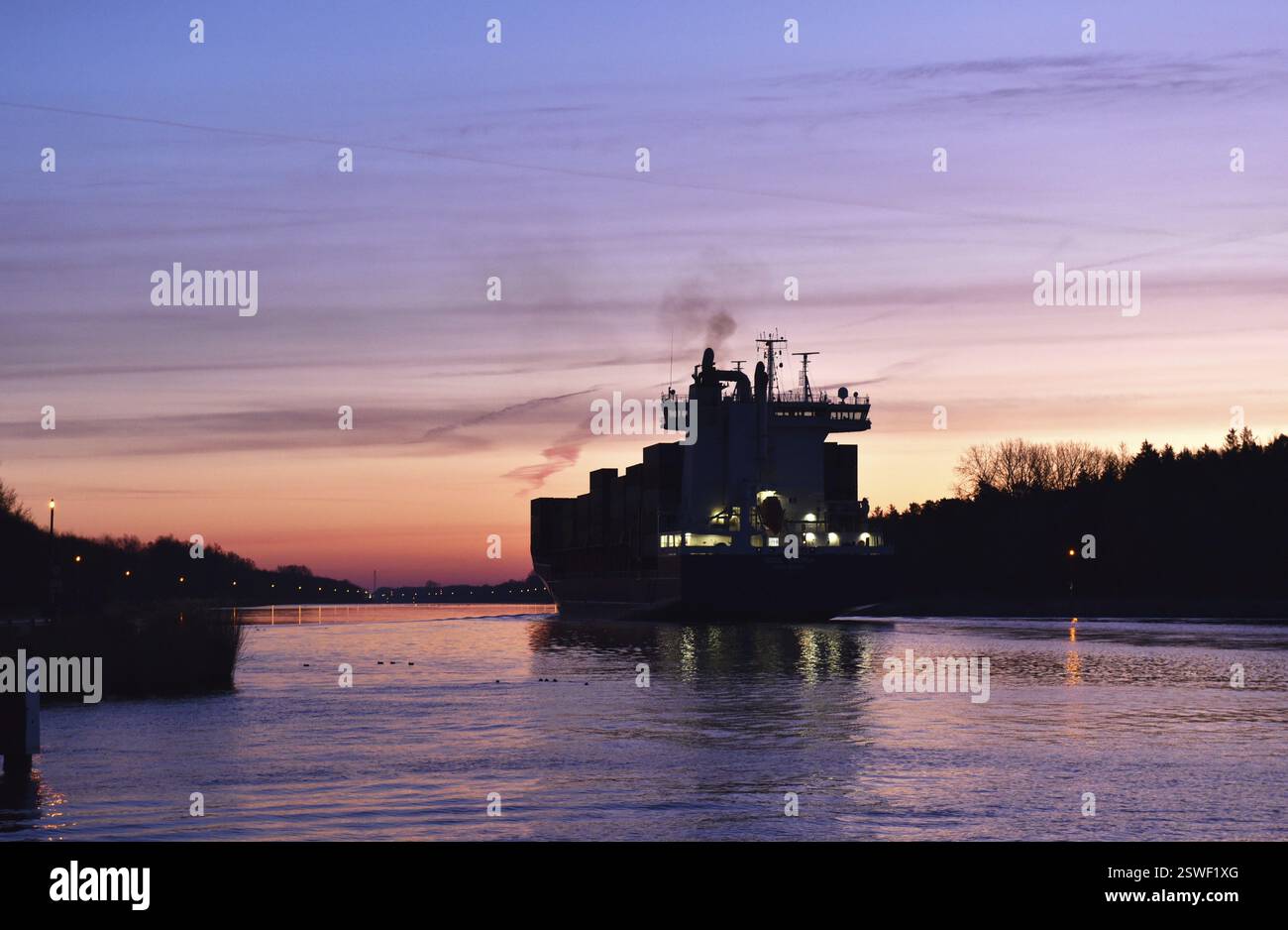 Container ship OOCL RAUMA at the blue hour, sunrise in the Kiel Canal ...