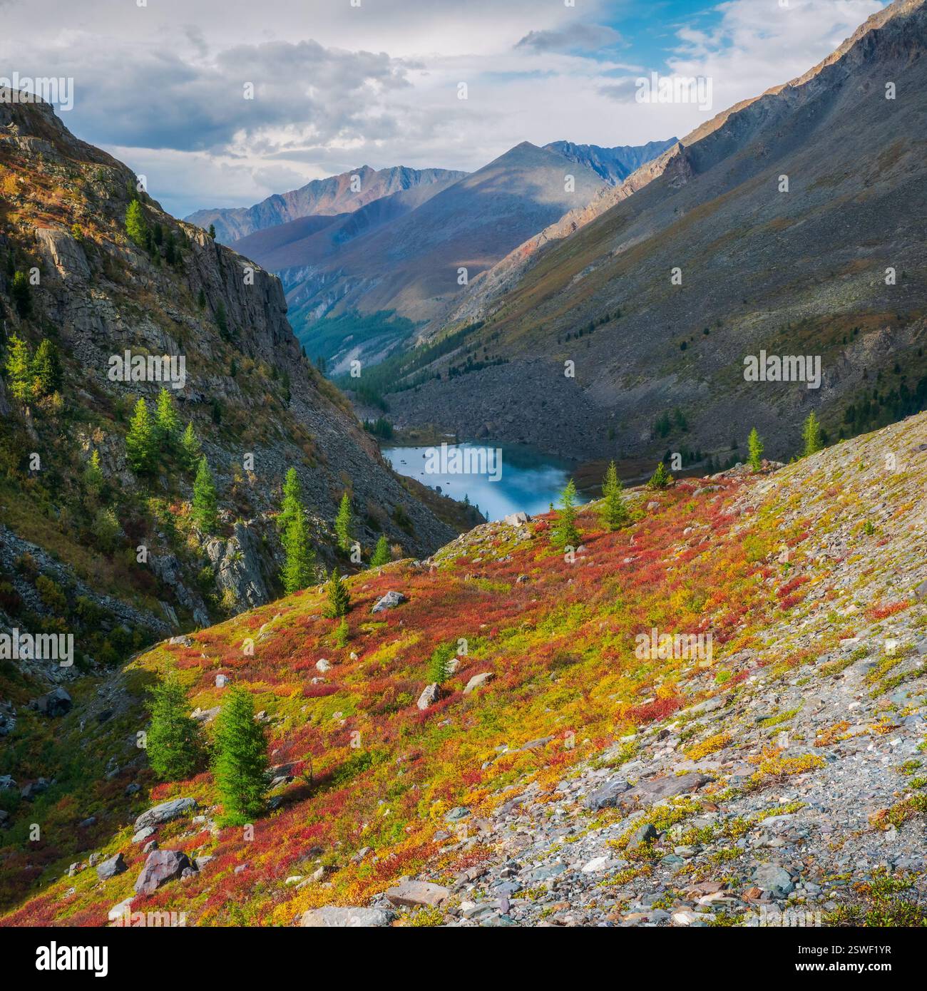 Awesome alpine panoramic view from pass to mountain valley in sunlight ...