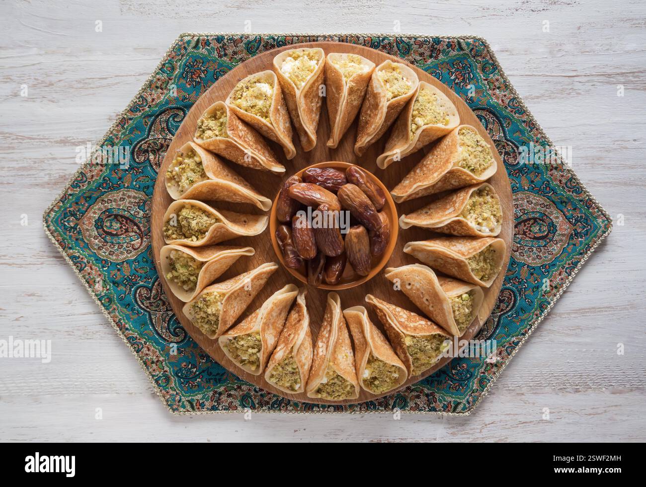 Arab sweets. Arabian pancake stuffed with sweet cheese and pistachios ...