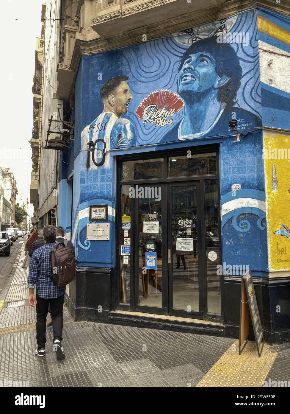 Entrance of a bar with pictures of Lionel Messi and Diego Maradonna ...