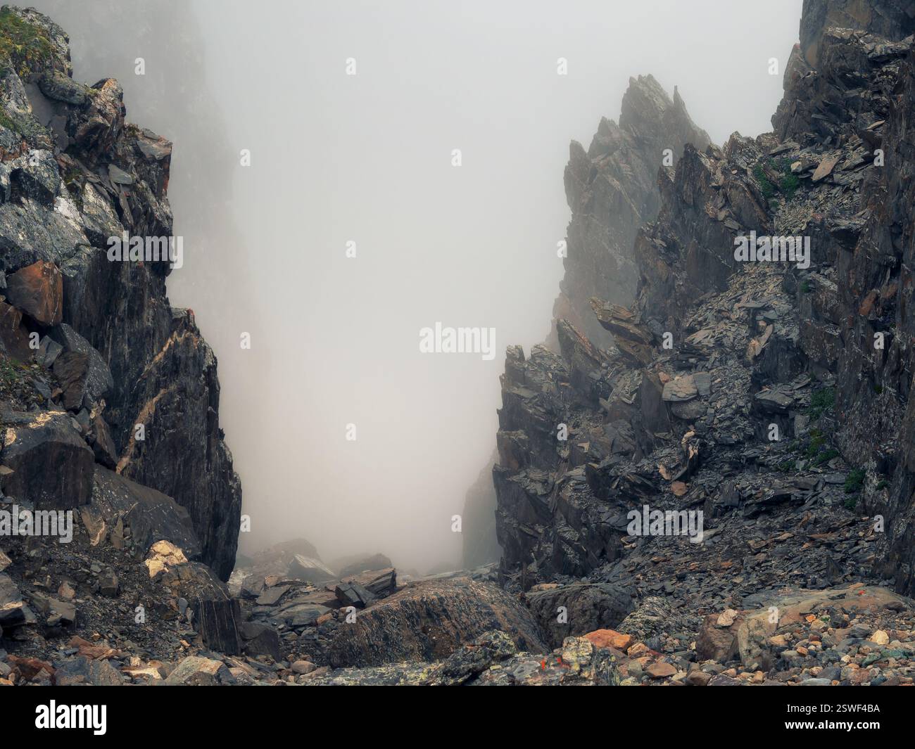 Horror mountain shadows. Dramatic fog among giant rocky mountains ...