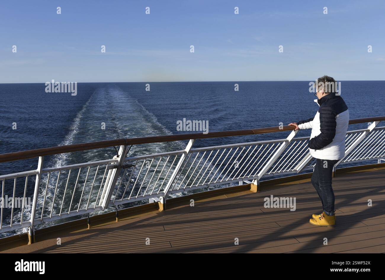 Woman standing at the stern of the ship Color Magic, cruise ship, ferry ...
