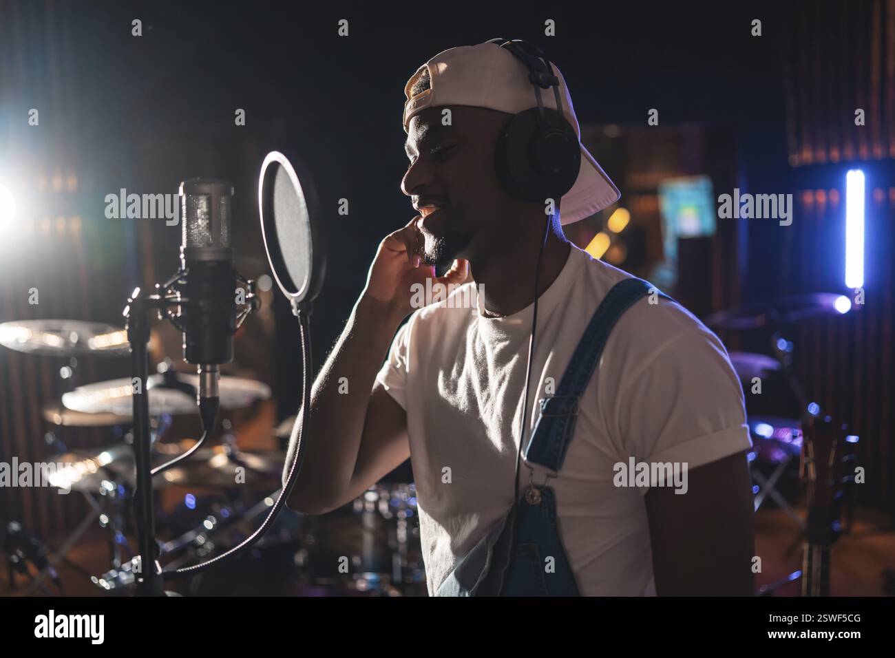 Talented musician passionately singing into a microphone, crafting a ...