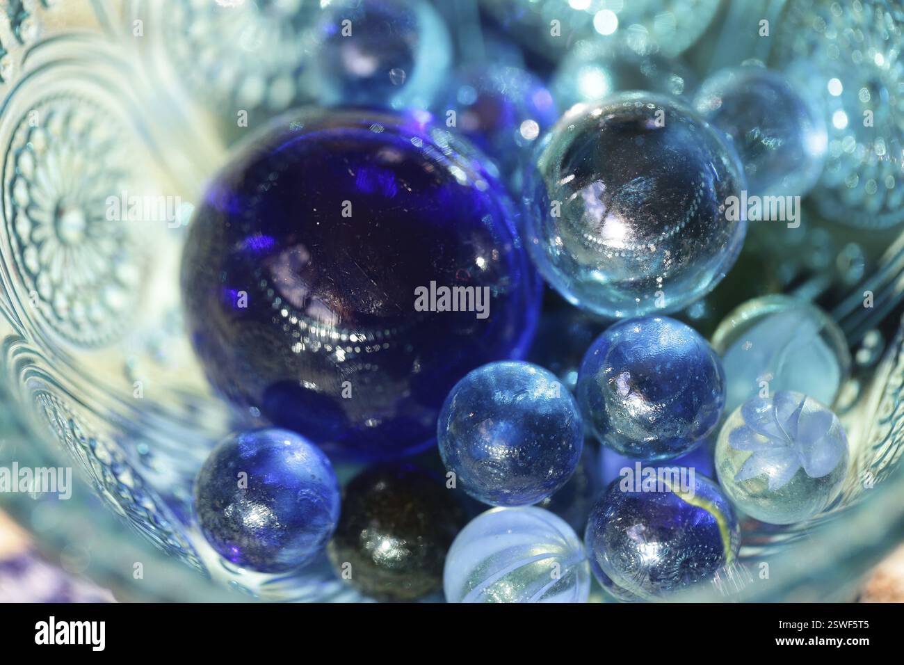 Blue marbles Glass marbles in a light blue bowl Stock Photo - Alamy