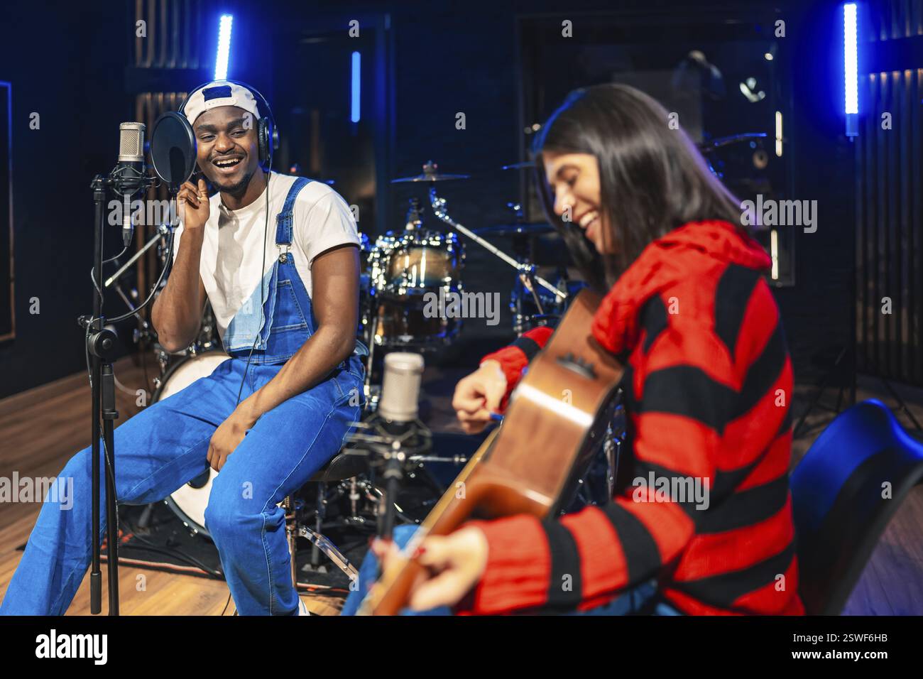 Two musicians collaborating, recording a song in a professional music ...