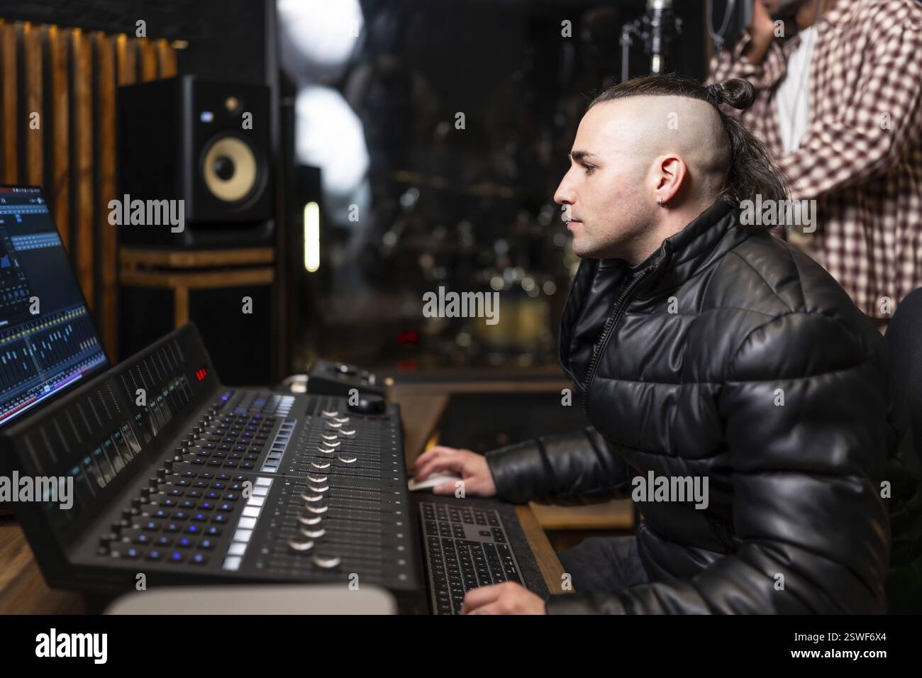 Sound engineer mixing music track using professional audio equipment in ...