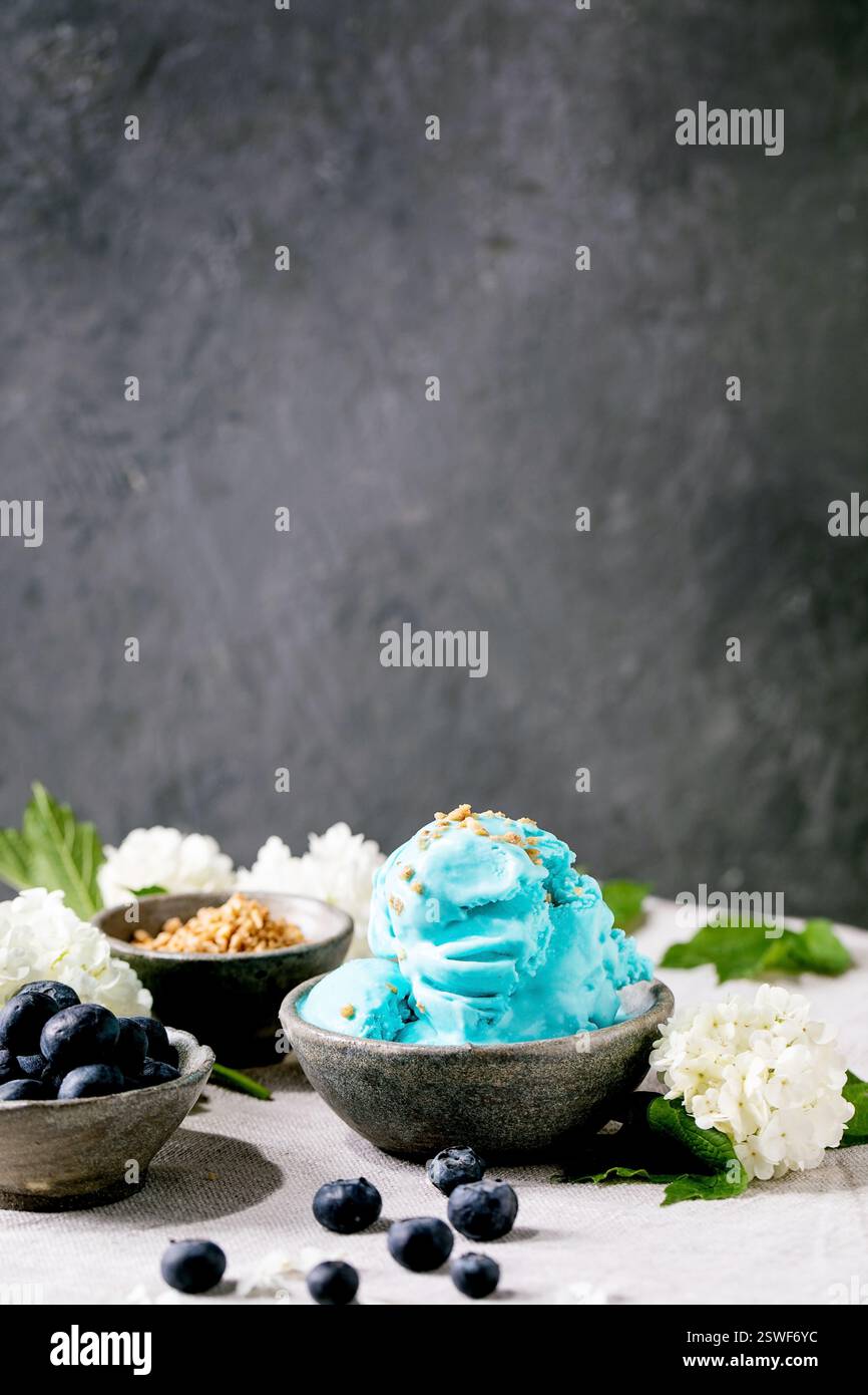 Turquoise ice cream with white flowers in waffle cones hi-res stock ...