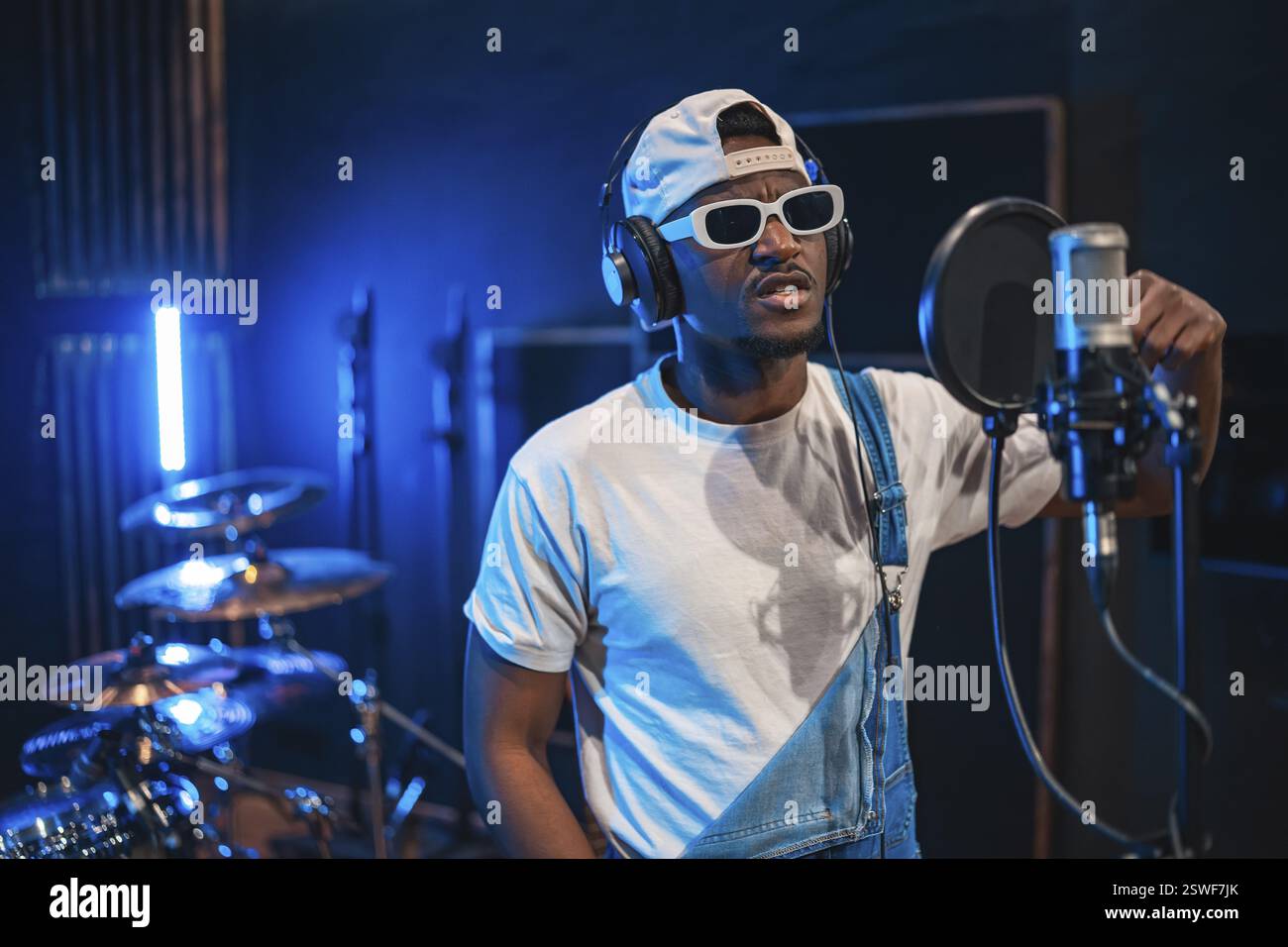 Young, stylish male singer captivating audiences while performing his ...