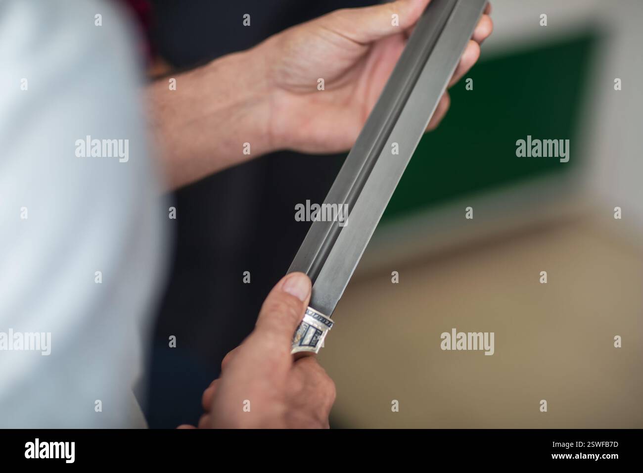 The blade of the saber. Hands of a dagger maker at work, close-up Stock ...
