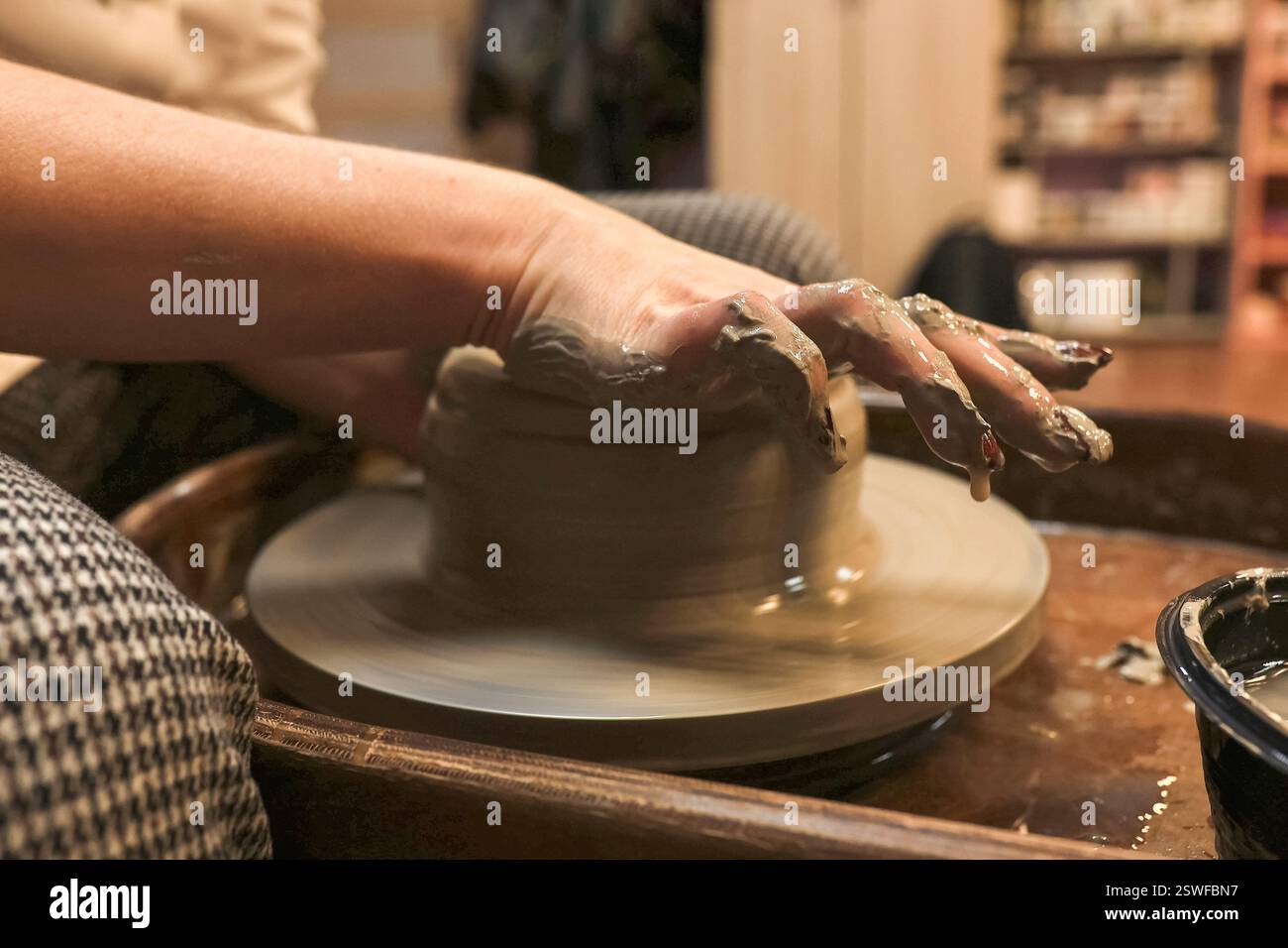 Clay potter artist making pot shape on wheel pedestal Stock Photo - Alamy
