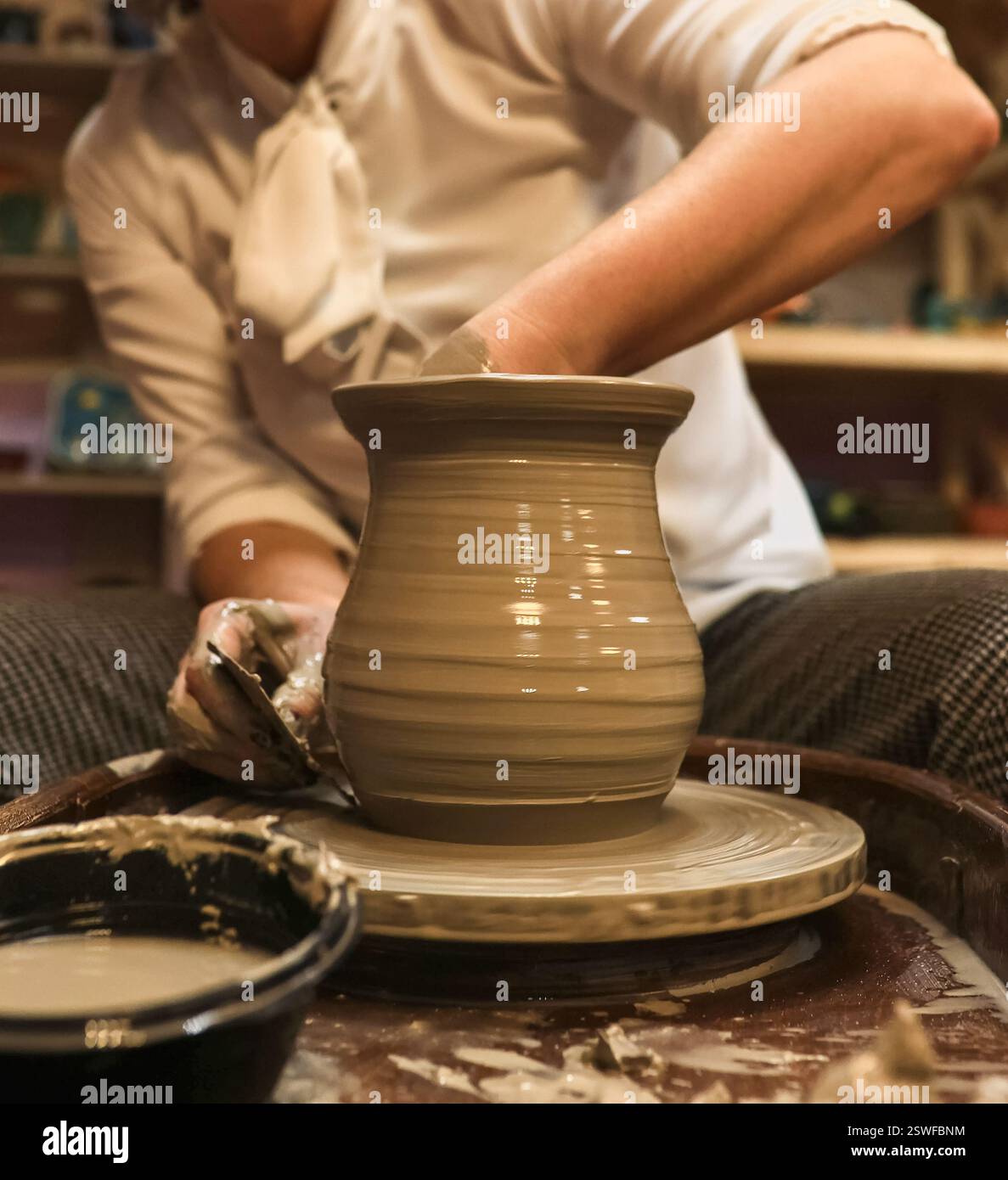 Clay potter artist making pot shape on wheel pedestal Stock Photo - Alamy