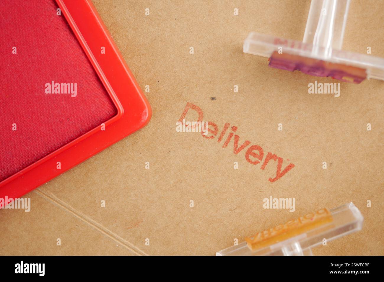 Delivery stamp and tools on brown paper background in workspace Stock ...