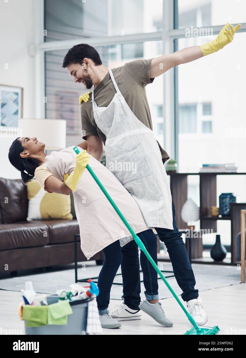 Cleaning, dancing and couple with mop in home playful for hygiene ...