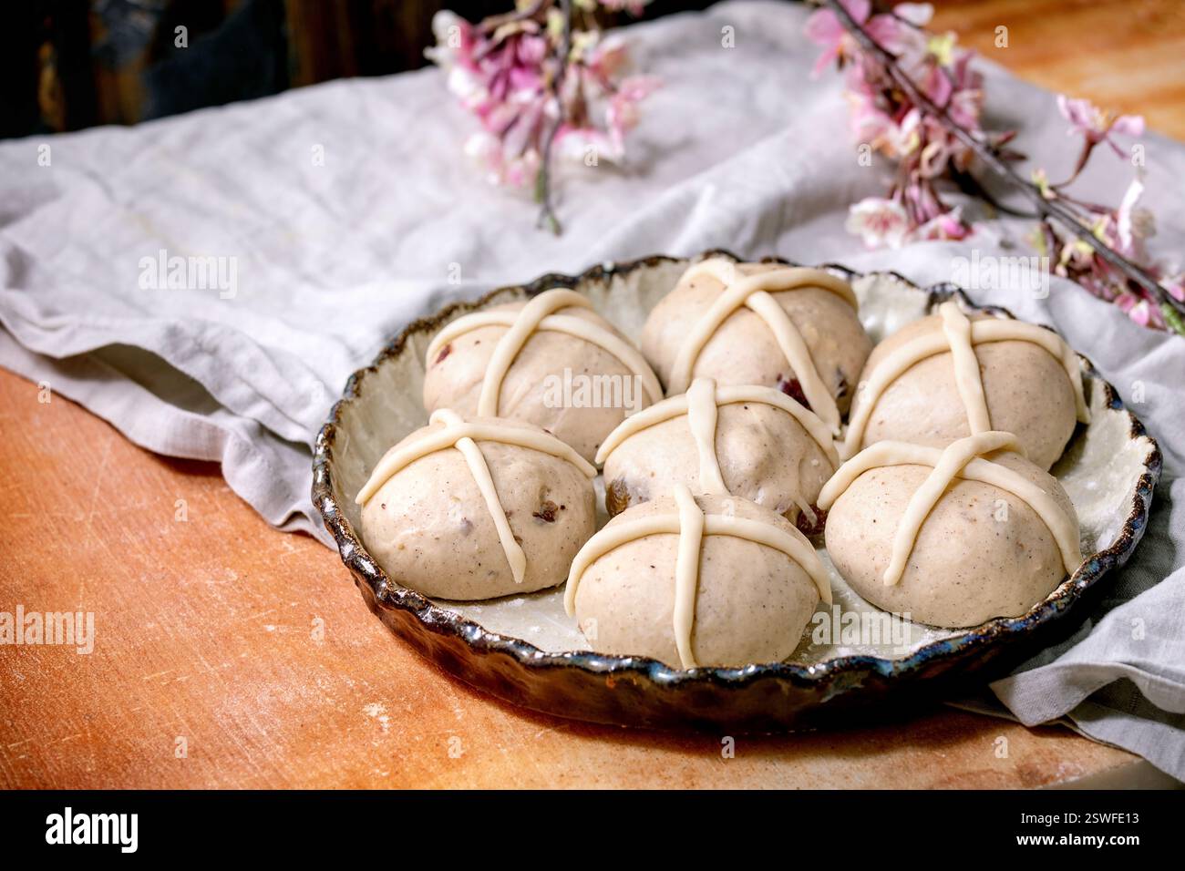 Raw unbaked homemade Easter traditional hot cross buns Stock Photo - Alamy
