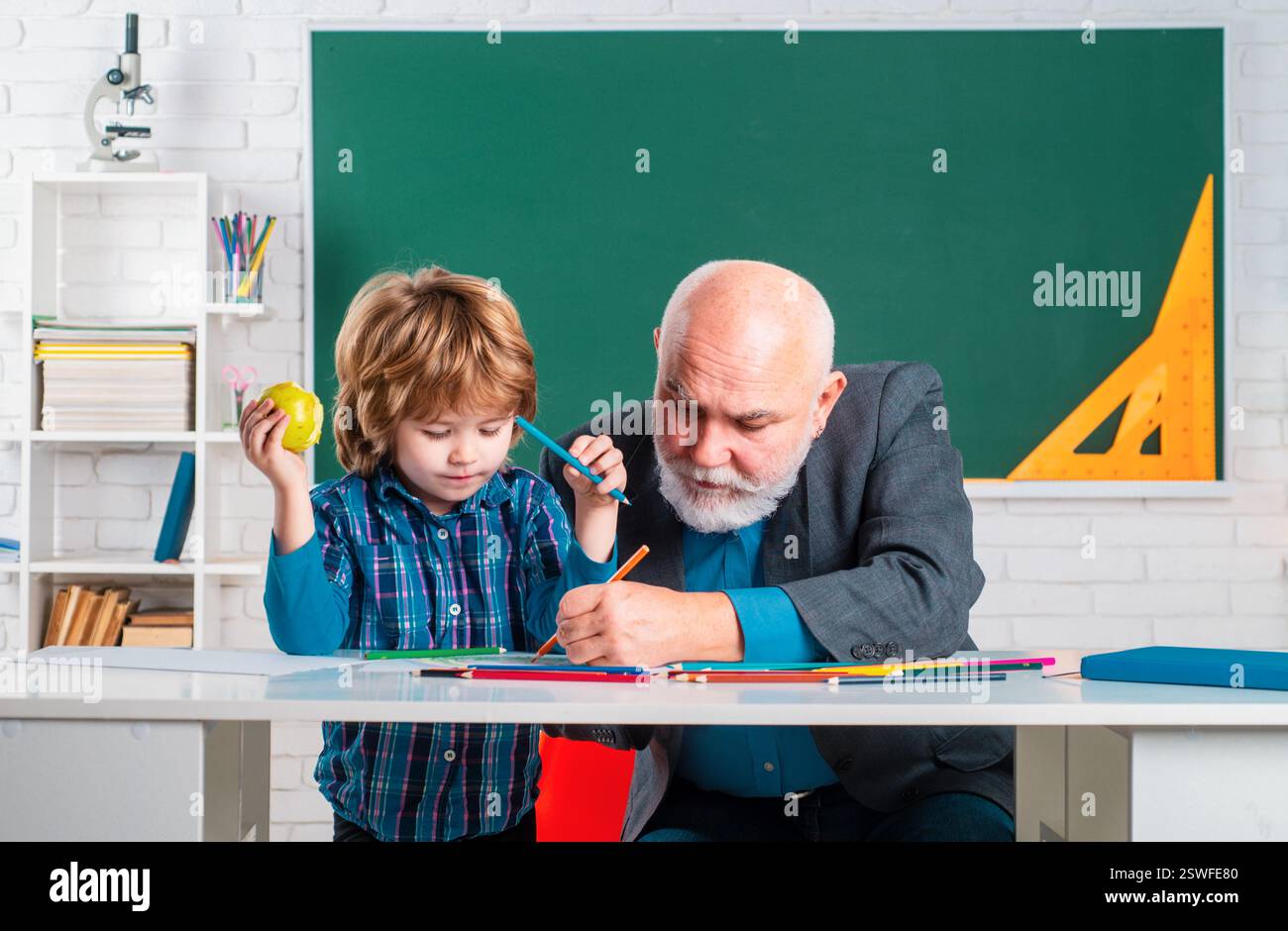 Elementary school. Senior teacher in classroom with elementary school ...