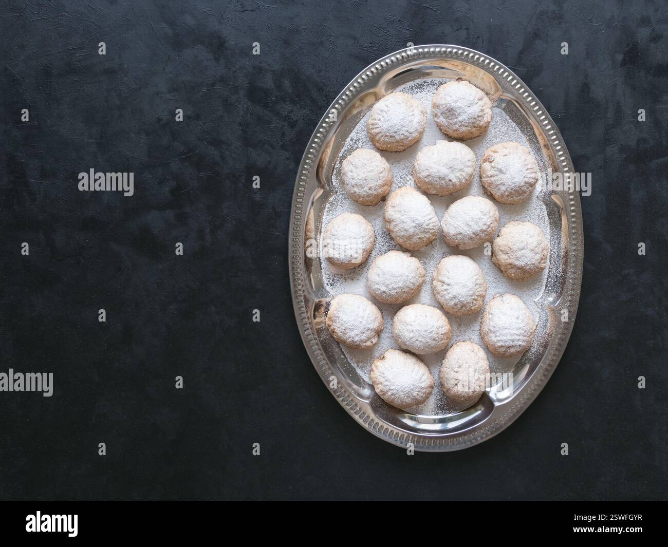 Ramadan sweets on the black table. Egyptian cookies Kahk El Eid ...