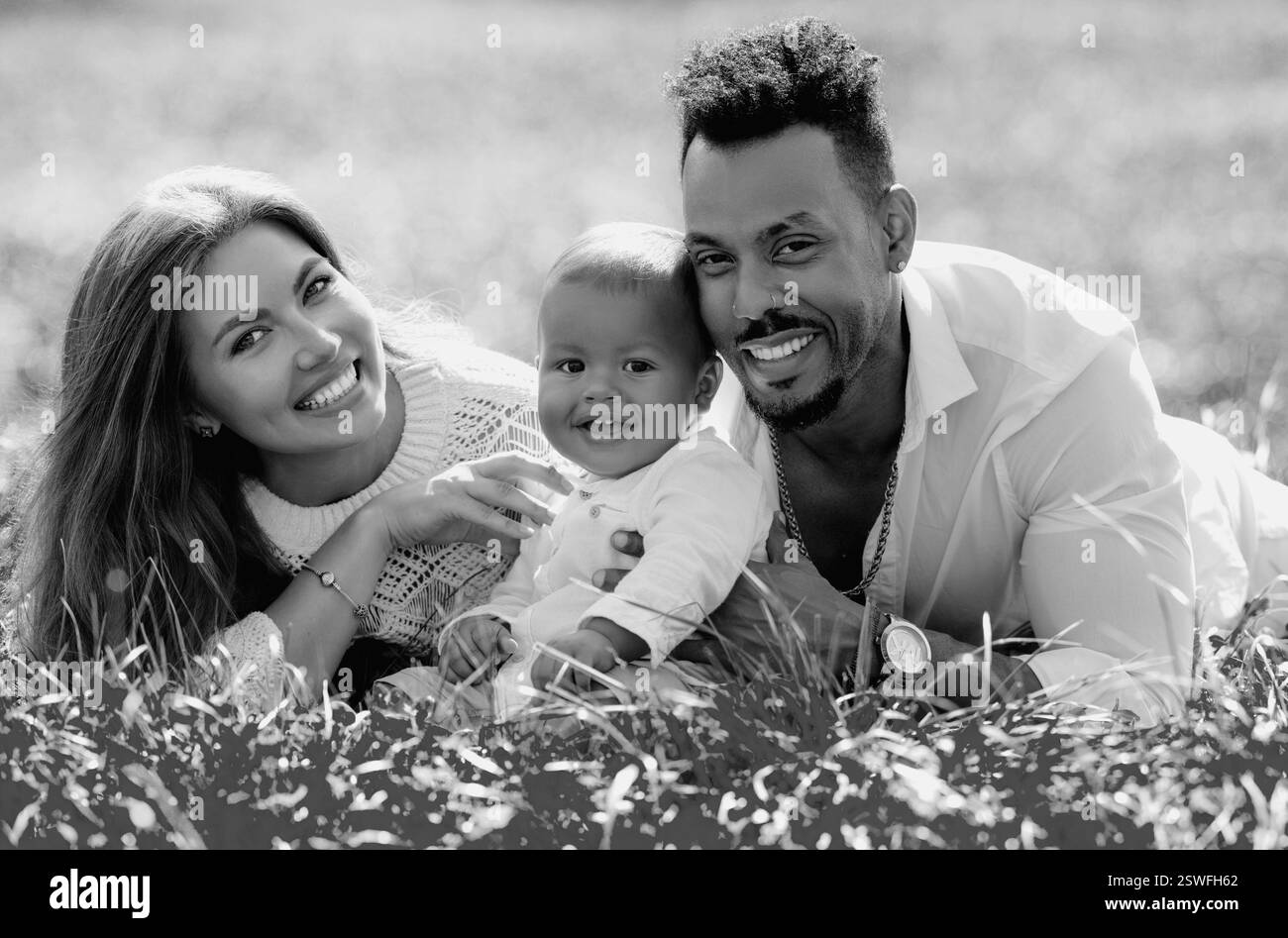 Multiethnic parents and mixed race baby in park. Multiracial family ...