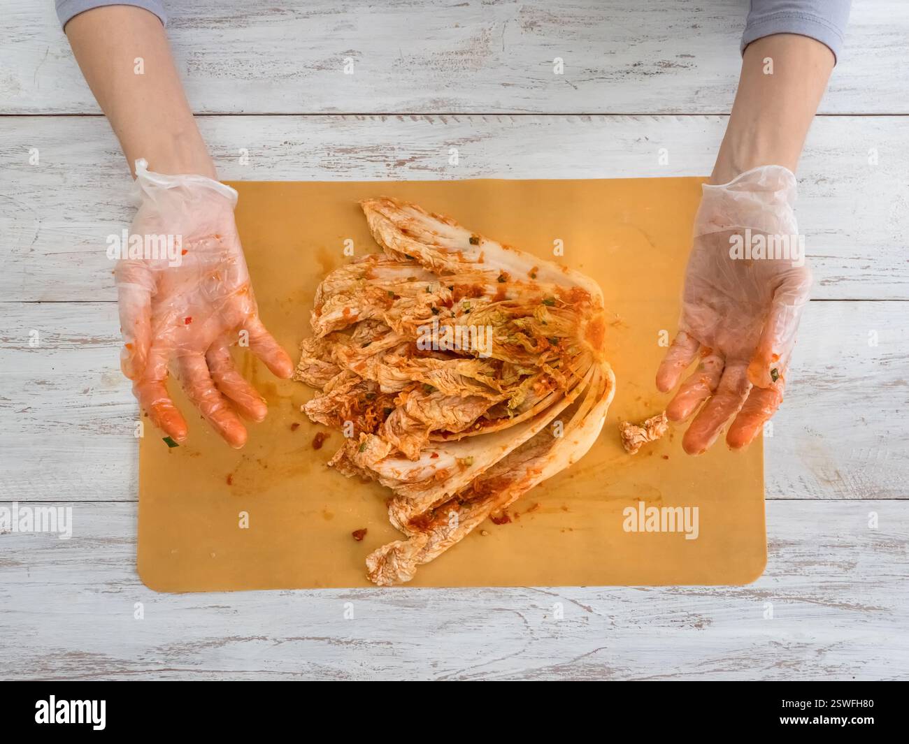 Gloved hands prepare Korean kimchi. Top view Stock Photo - Alamy