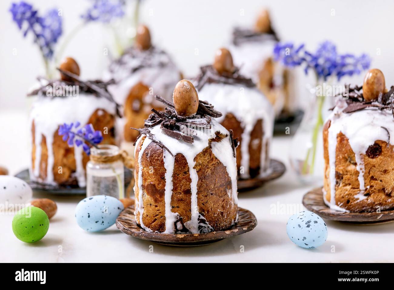 Homemade traditionla small Easter kulich cakes with chocolate nests and ...