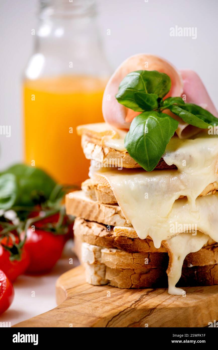 Stockpile of toasted melted cheese pressed sandwiches with ham meat ...