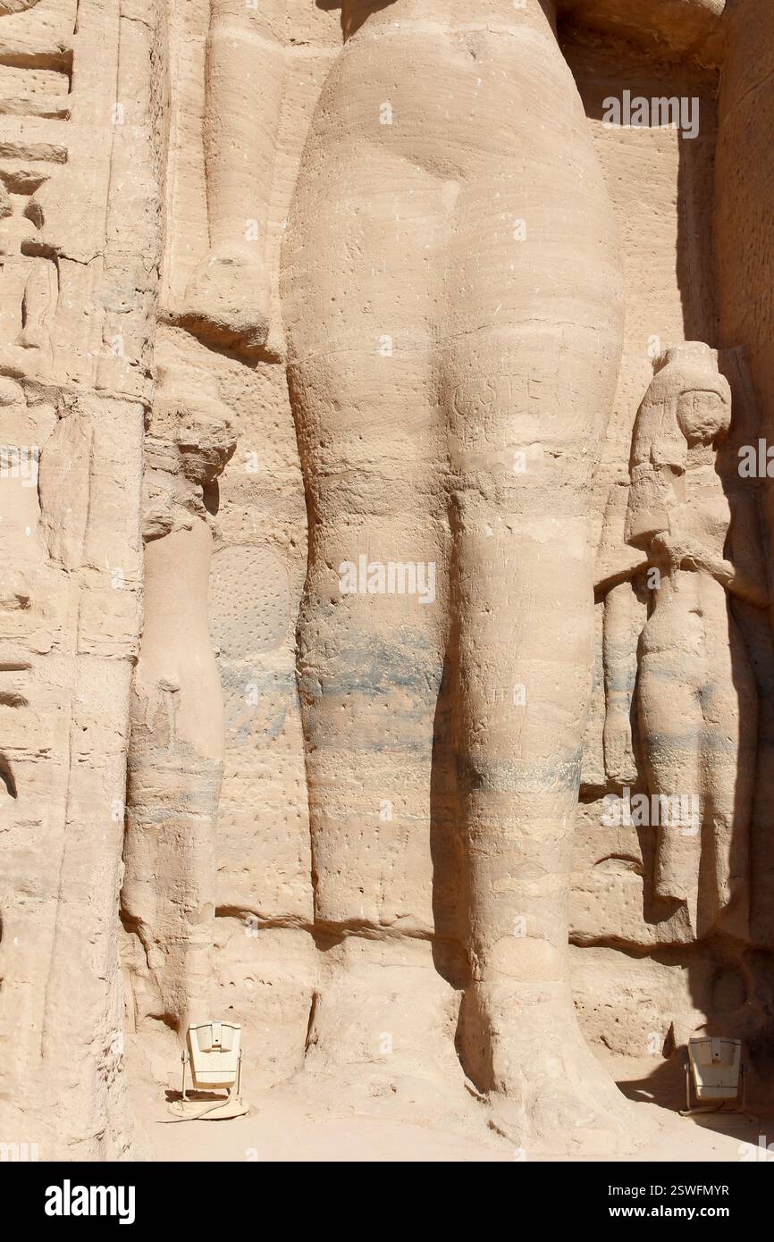 Smaller statues beside the standing colossal Ramses and Nefertari ...