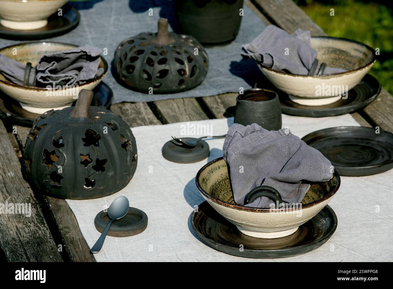 Rustic table setting outside in garden with empty craft ceramic ...