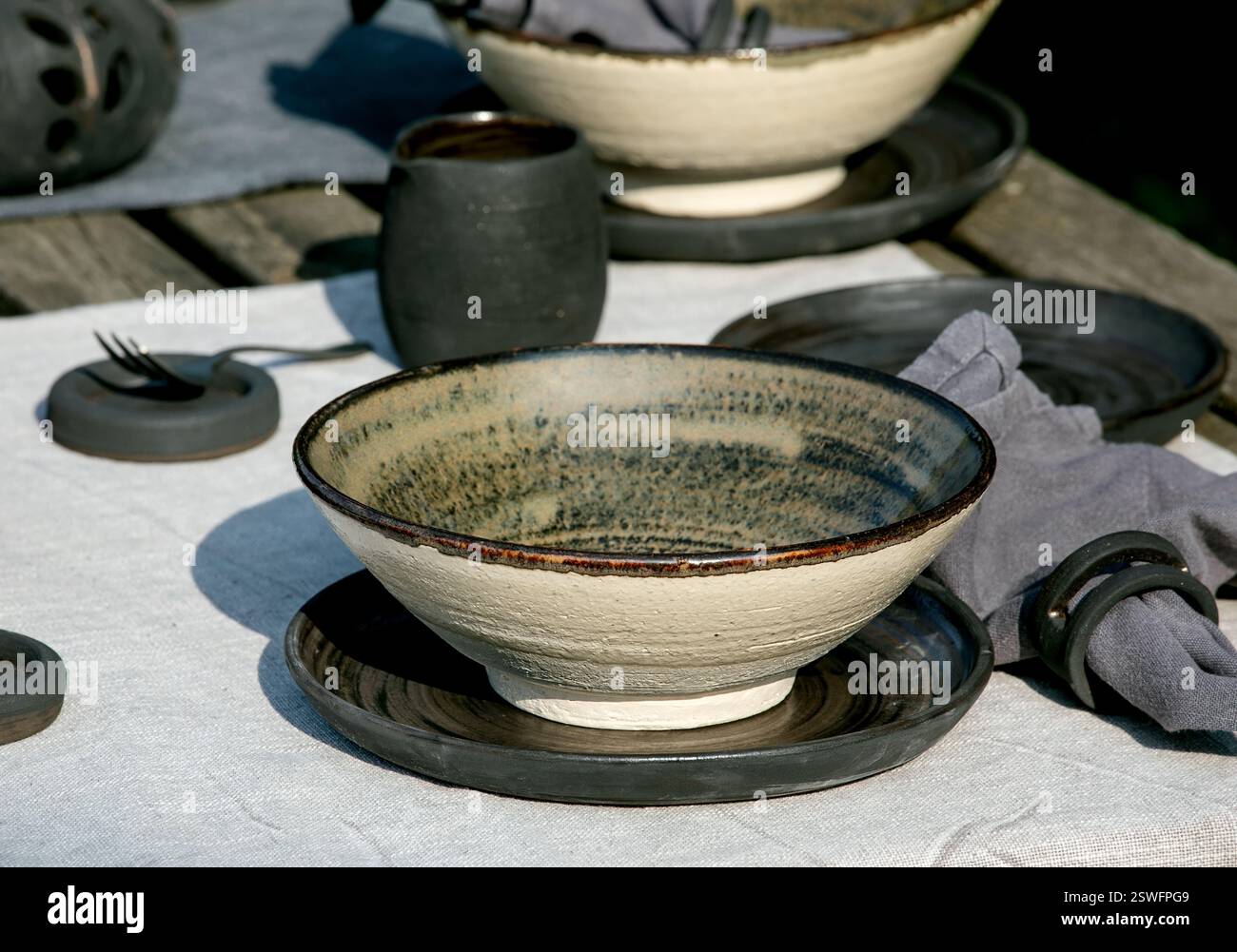 Rustic table setting outside in garden with empty craft ceramic tableware Stock Photo - Alamy