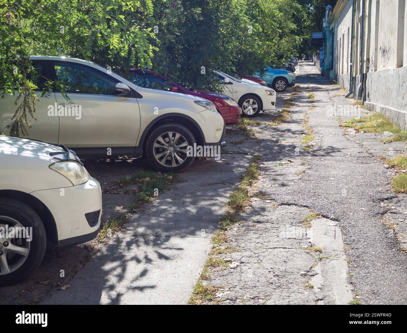 Car Parking on the broken sidewalk in Chisinau. Moldova Stock Photo - Alamy
