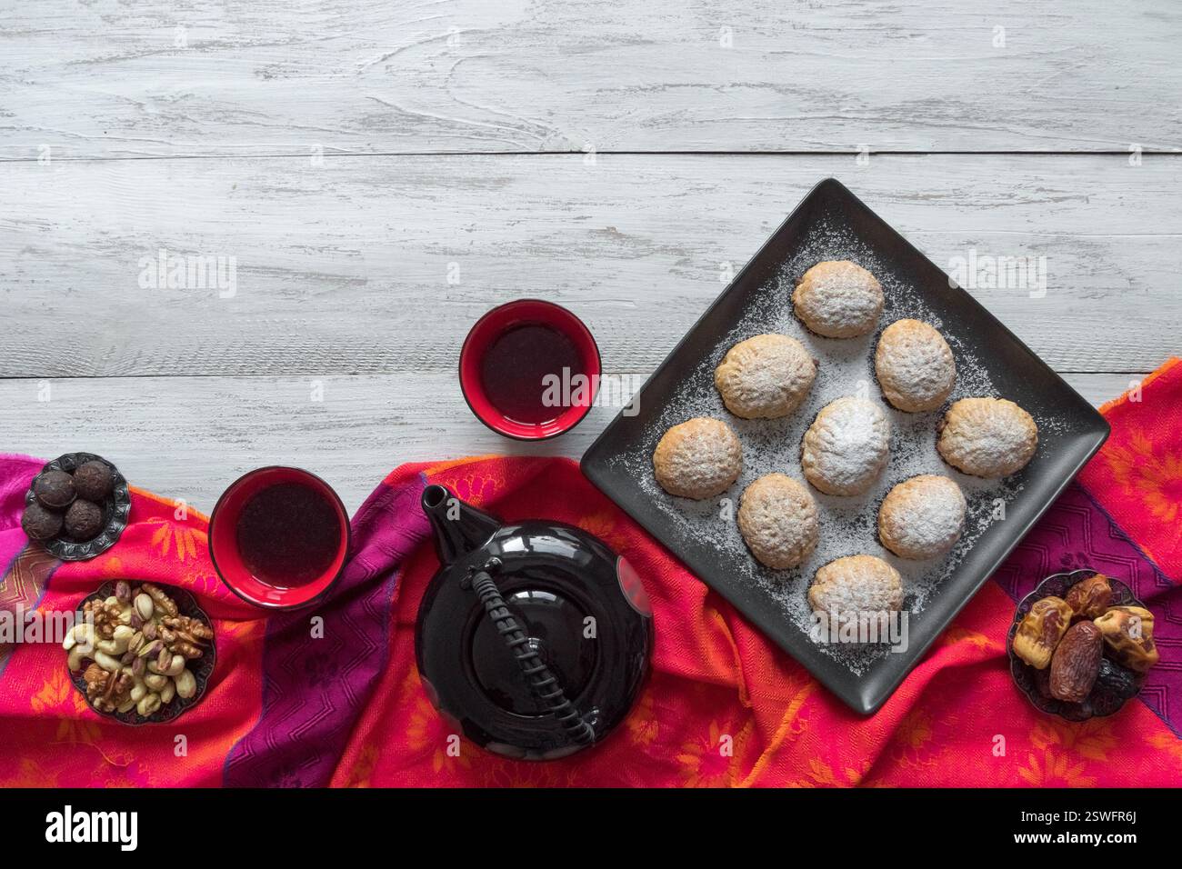 Handmade Ramadan sweets are served with tea on the table. Egyptian ...