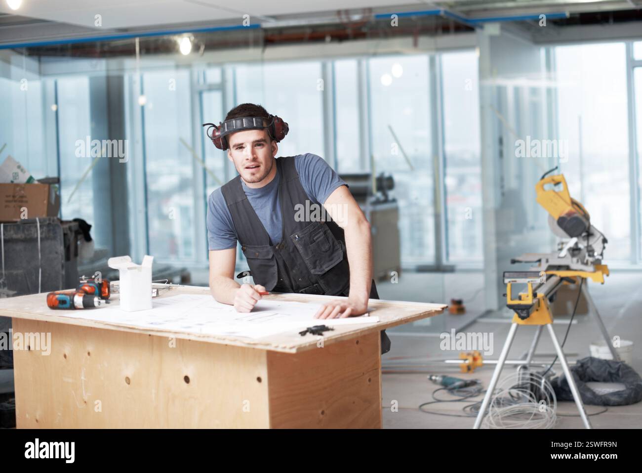 Man, plans and carpenter with construction site, portrait and drawing ...