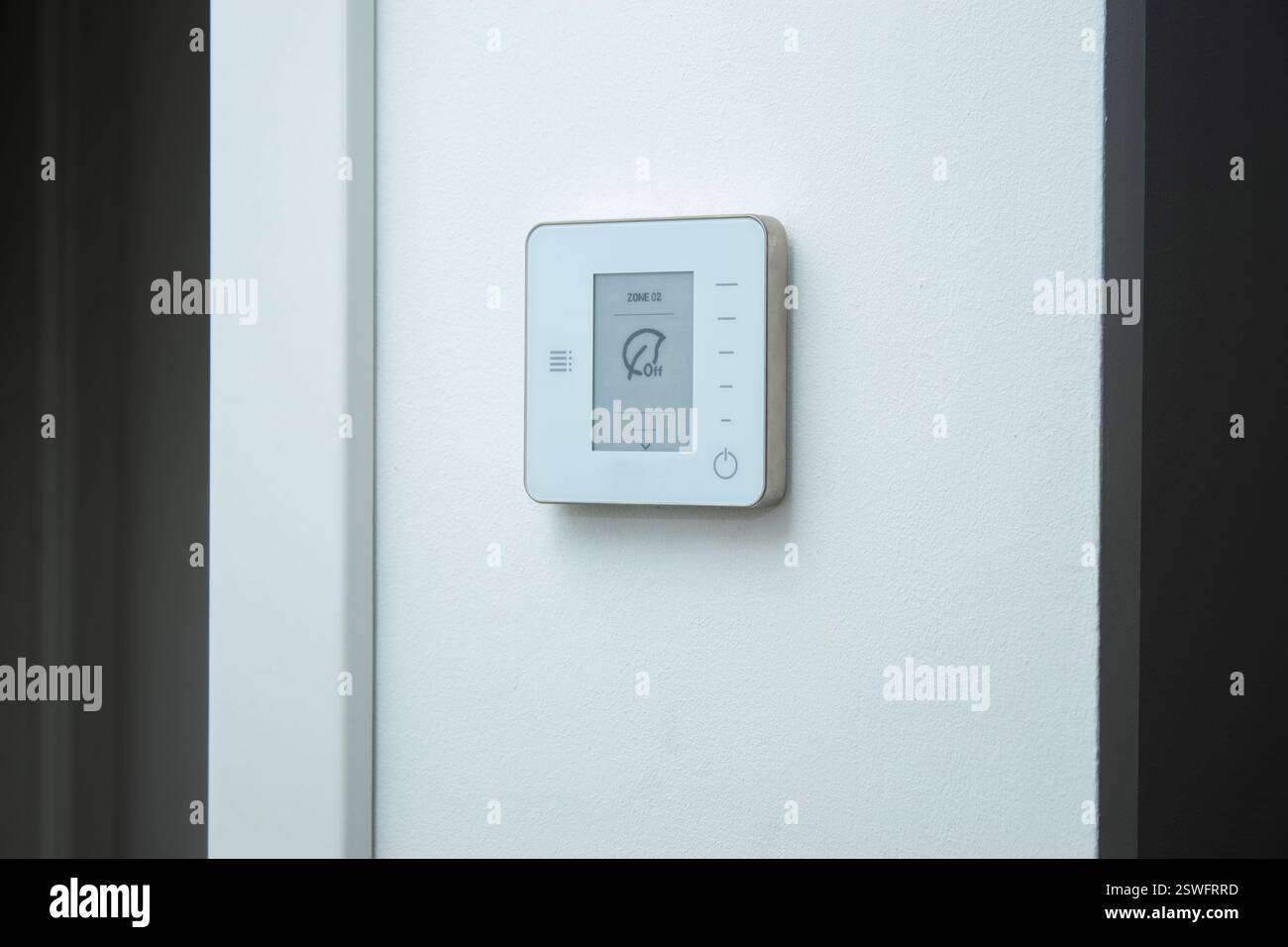 A modern electric thermostat control system on white wall Stock Photo ...