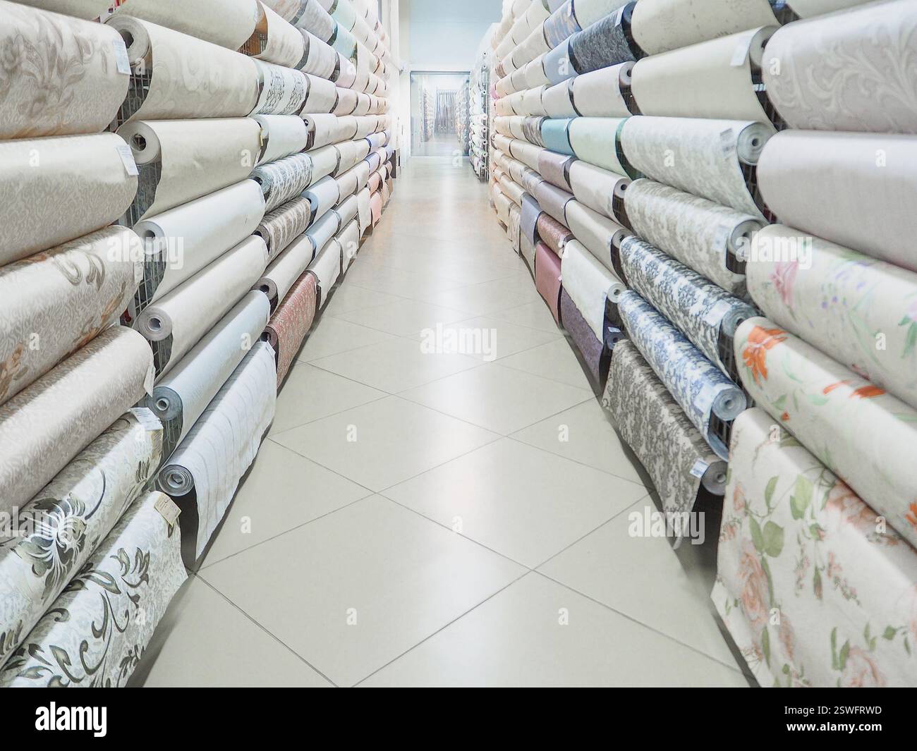 Wallpaper rolls on store shelves. Large selection of wallpaper rolls ...