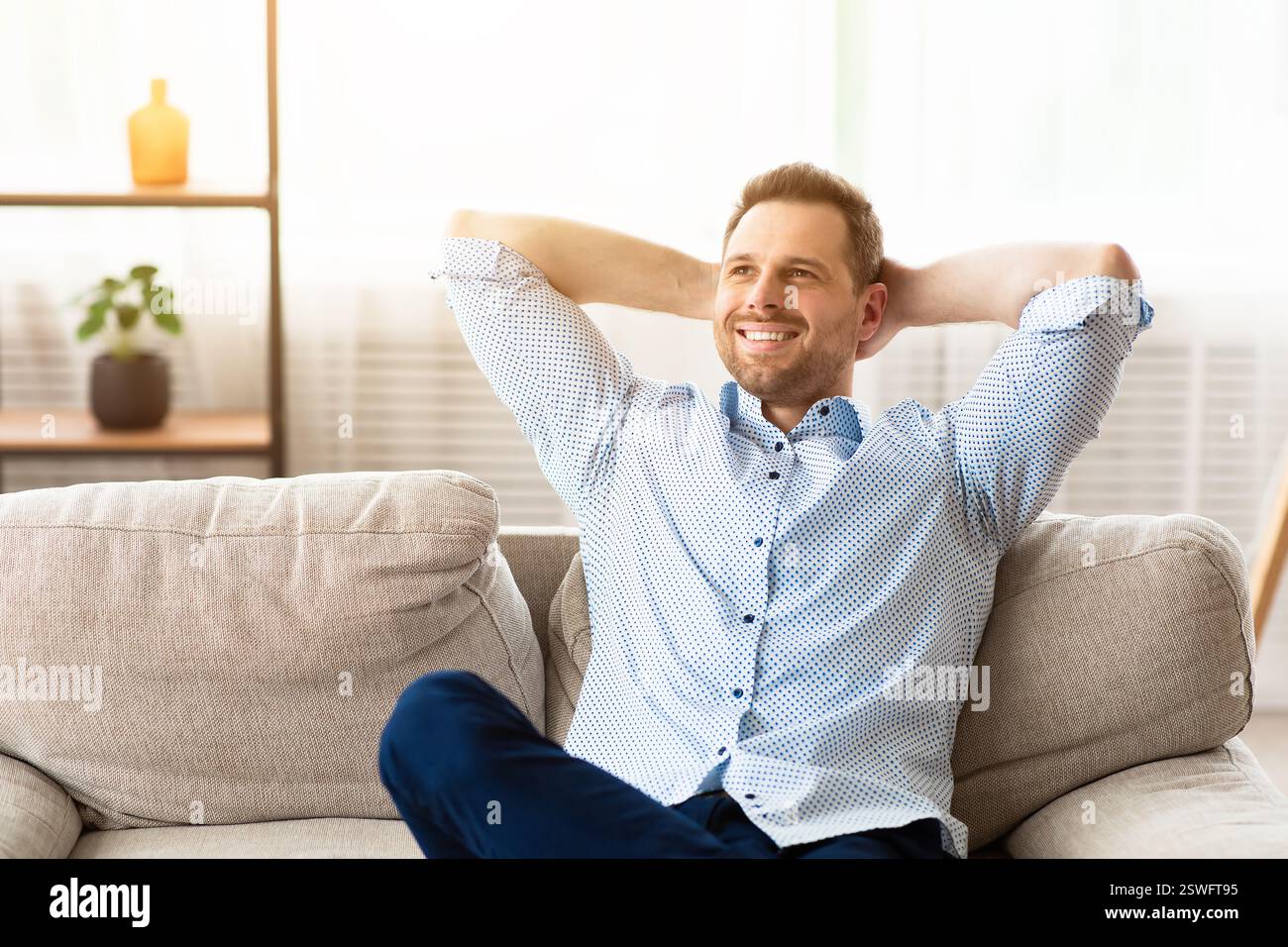 Guy having rest at home on the sofa Stock Photo - Alamy