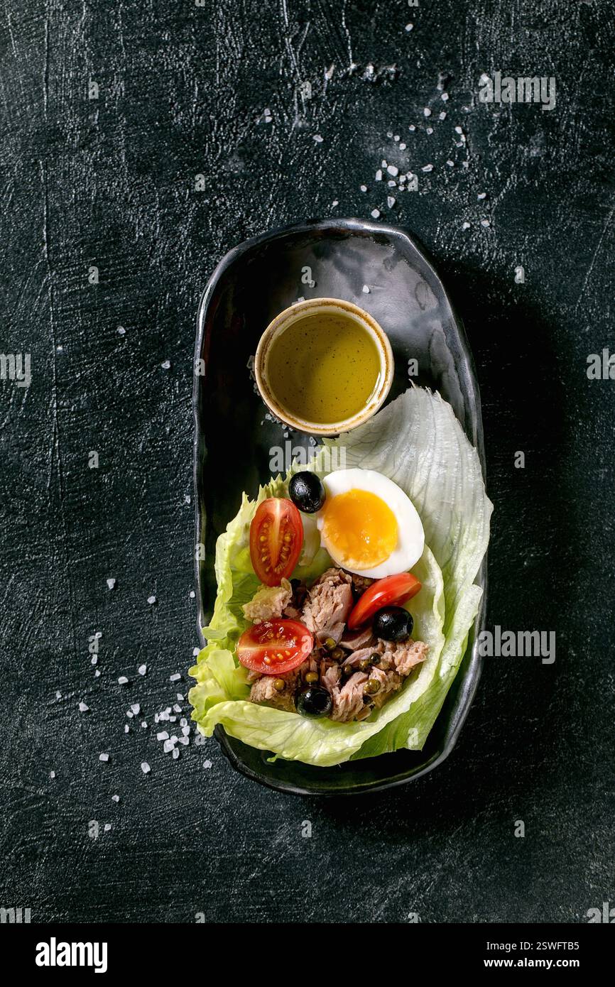 Traditional nicoise salad with canned tuna fish, olives and eggs ...