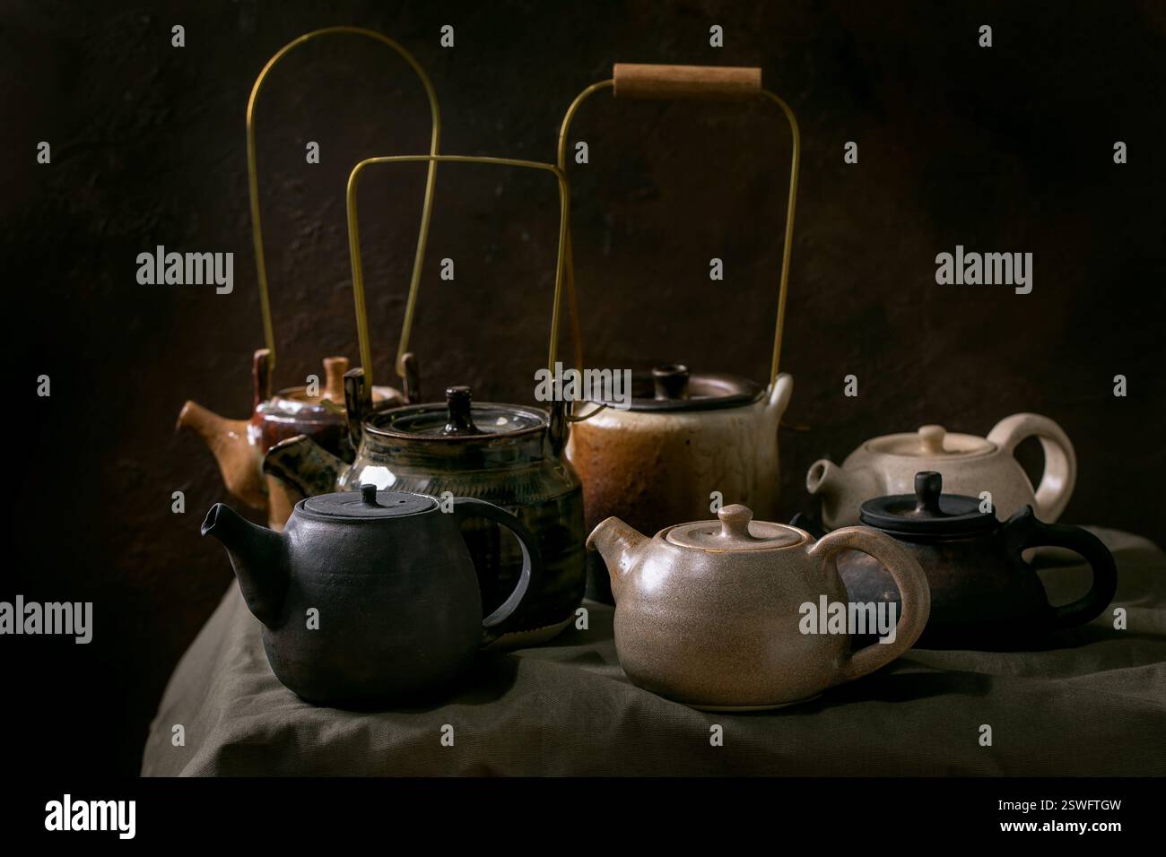 Set of craft handmade ceramic teapots with dark background Stock Photo ...
