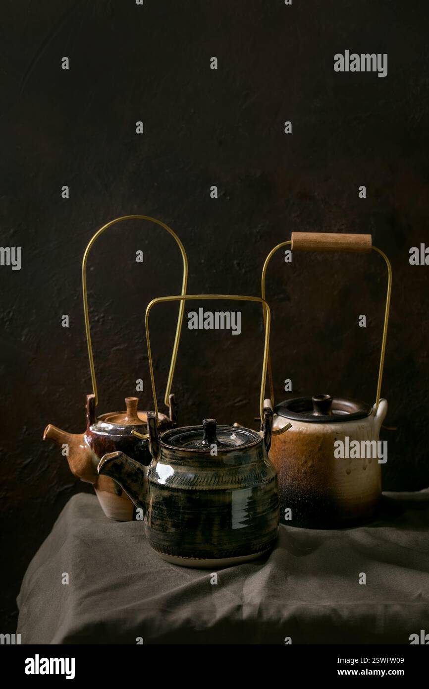 Set of craft handmade ceramic teapots with dark background Stock Photo ...