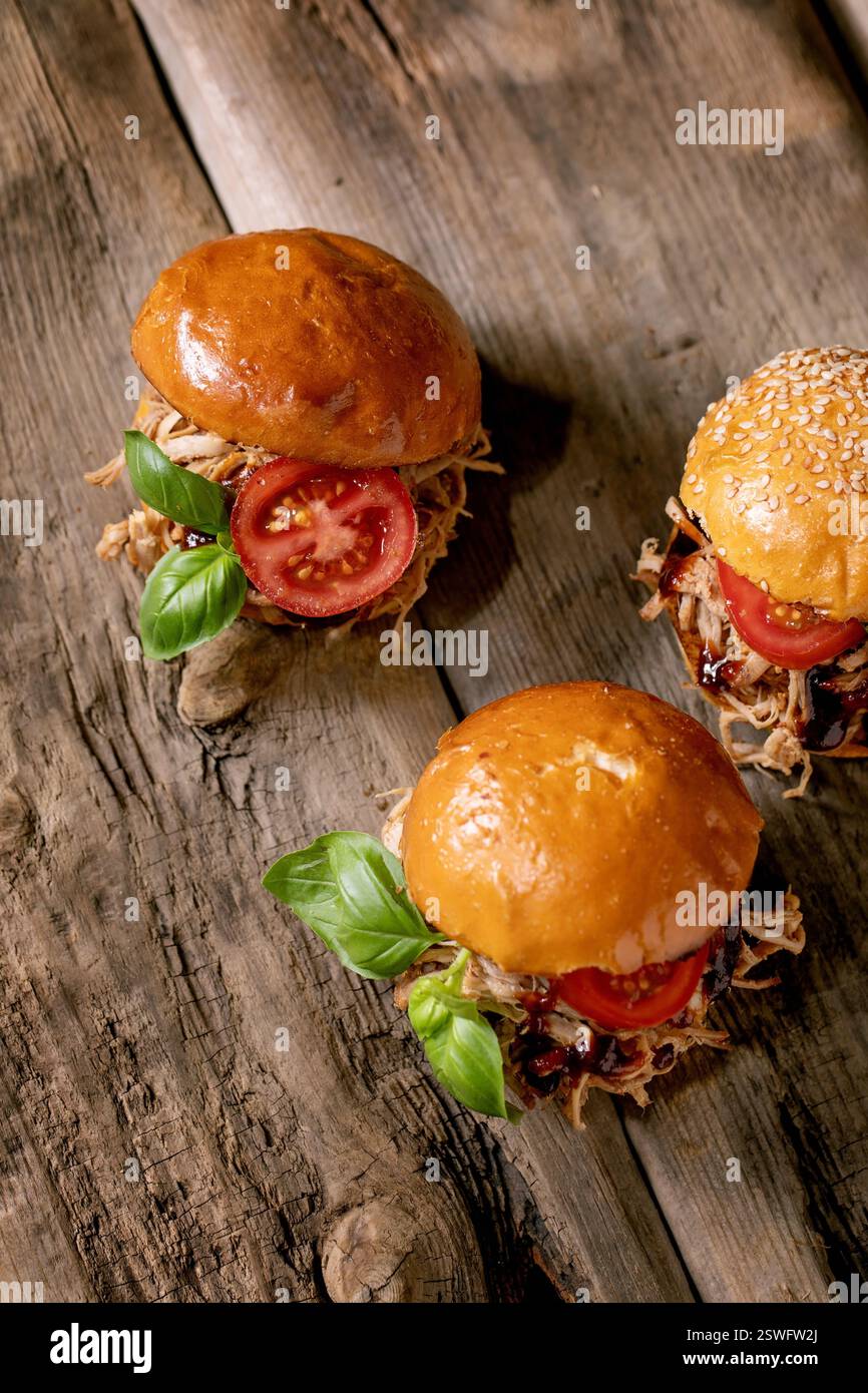 Set of fresh mini burgers with stew beef, tomatoes and basil on wooden ...