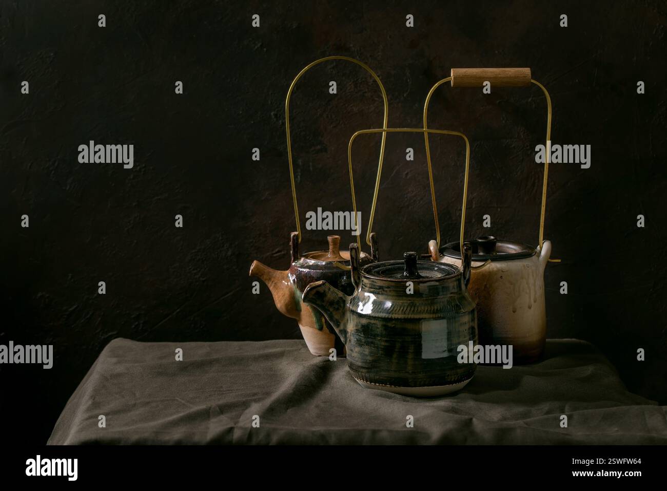 Set of craft handmade ceramic teapots with dark background Stock Photo ...